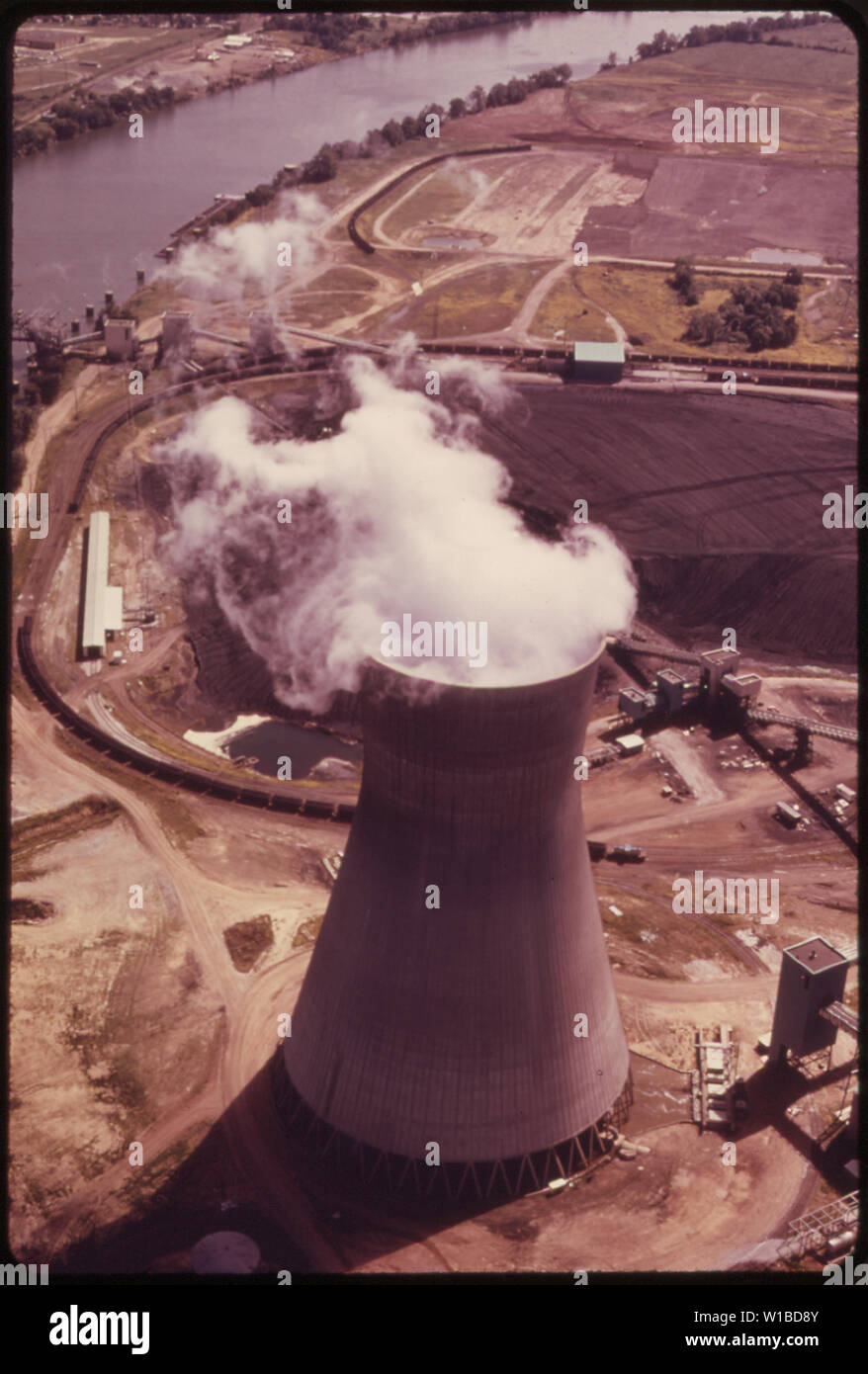 CLOUD OF STEAM RISES FROM ONE OF THE MASSIVE COOLING TOWERS OF THE JOHN ...