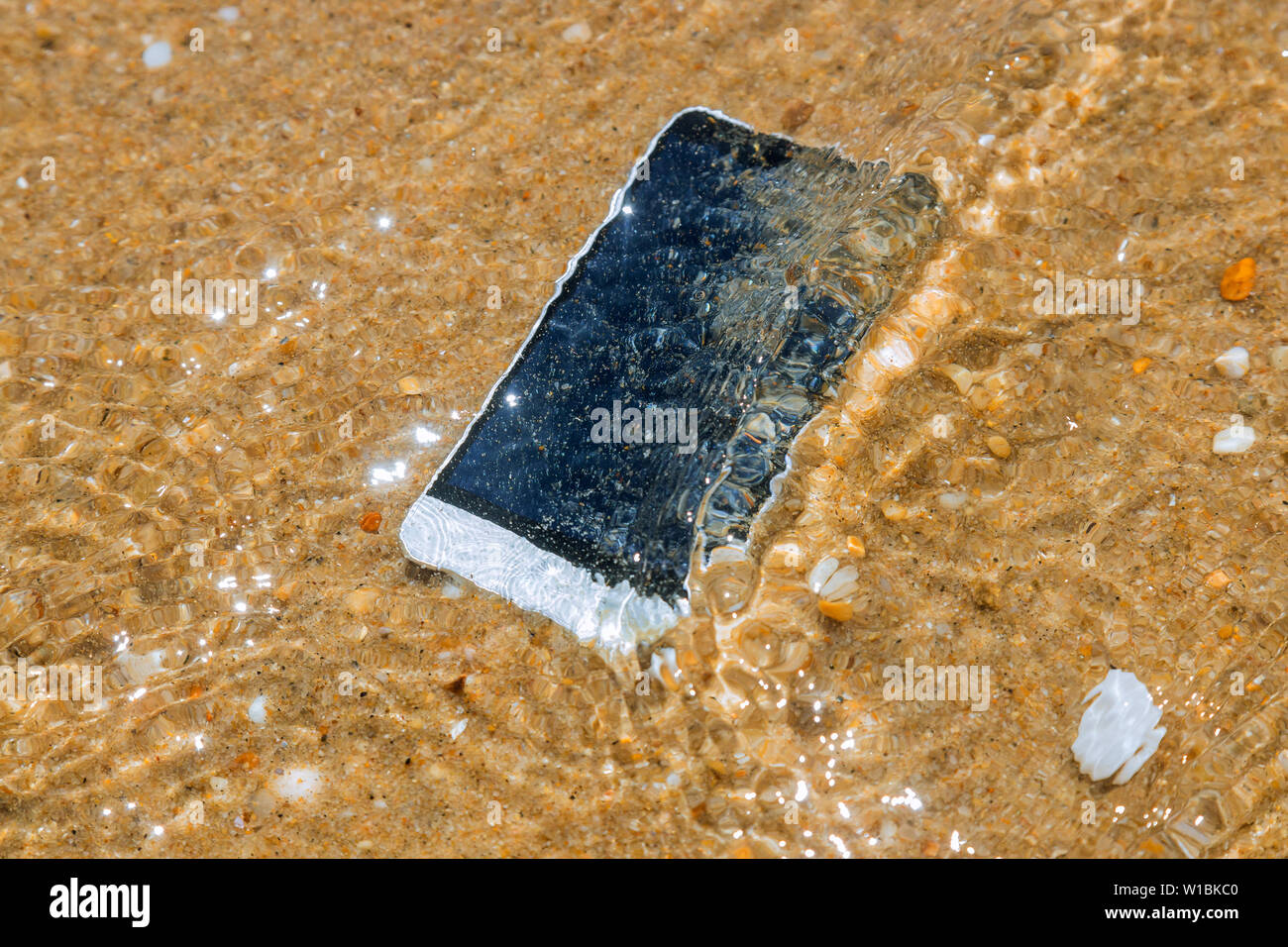 Smart phone with weather on a sandy beach of sea background Stock Photo ...