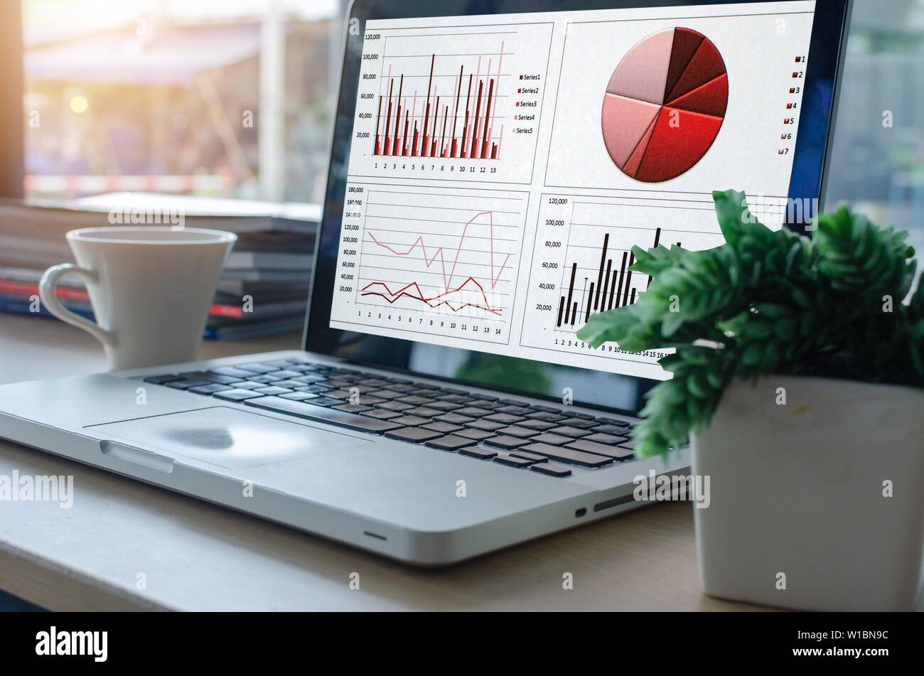 laptop laptop and smartphone with graphs, diagrams and charts on screen ...