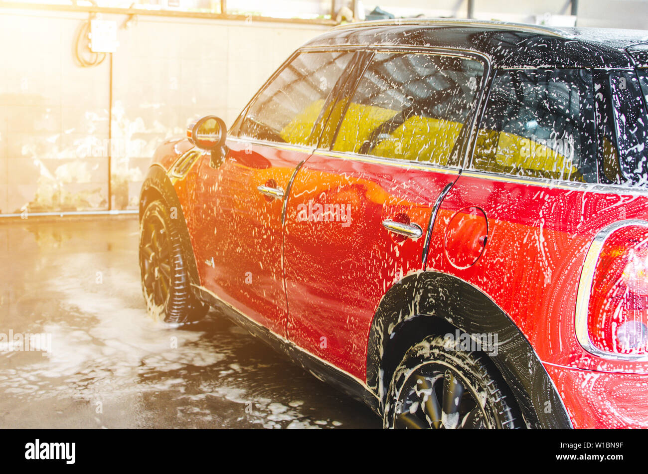Red car wash with foam Stock Photo - Alamy