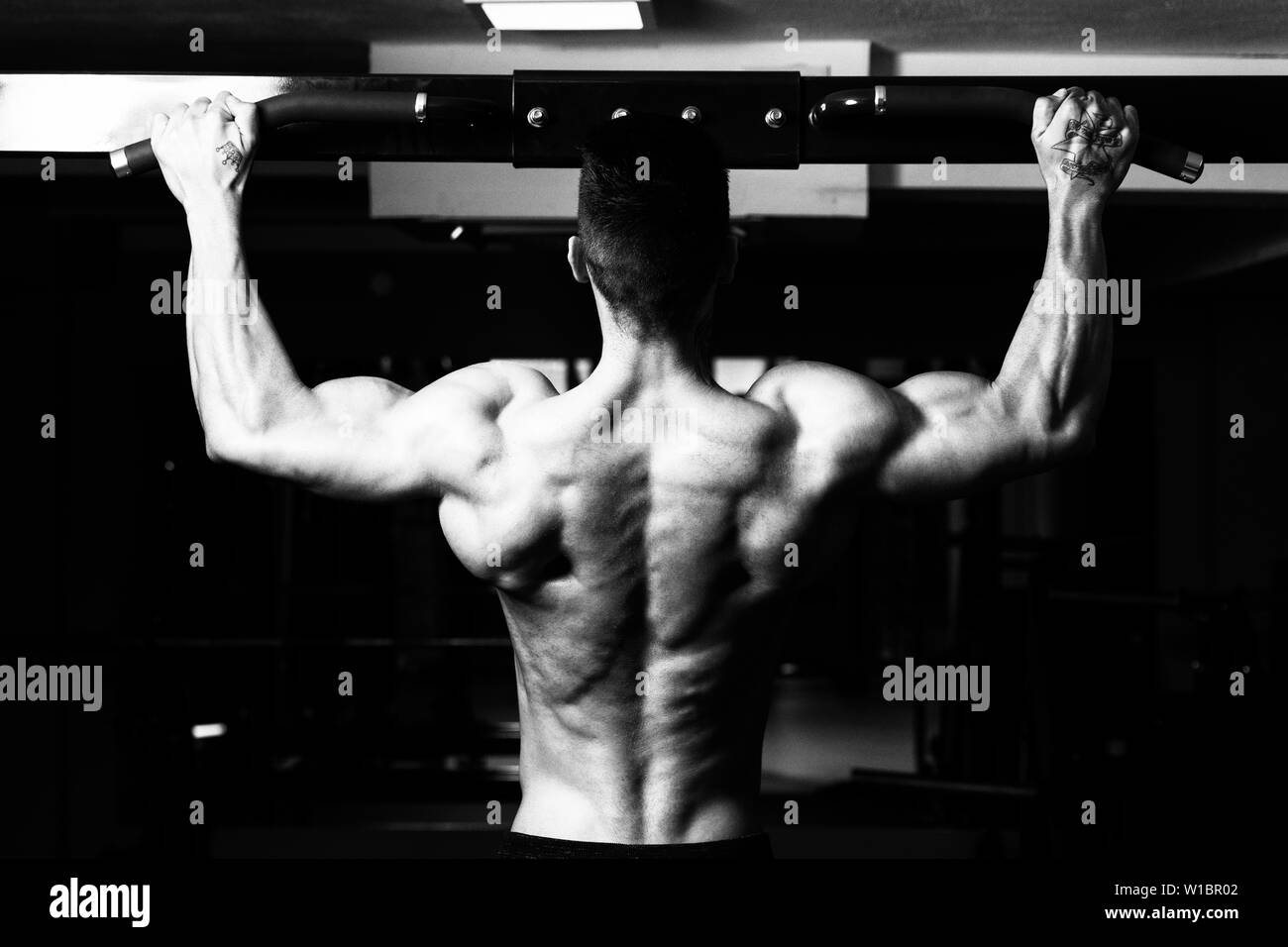 Pull ups exercise back Black and White Stock Photos & Images - Alamy