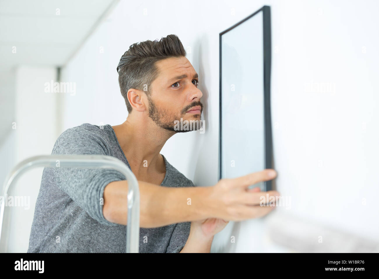 Man looking at poster wall hi-res stock photography and images - Alamy