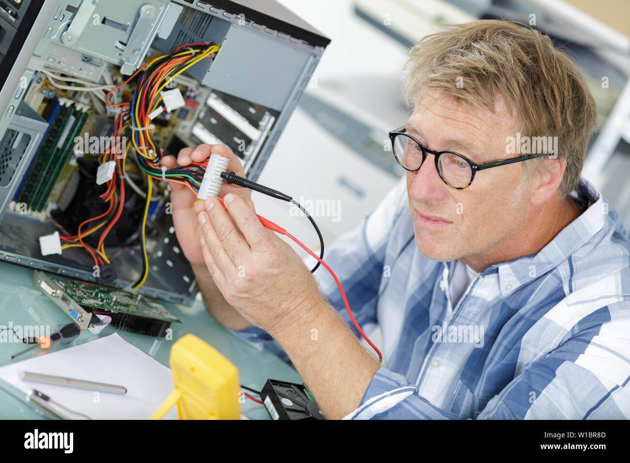 mature man fixing an old desktop computer using a screwdriver Stock ...
