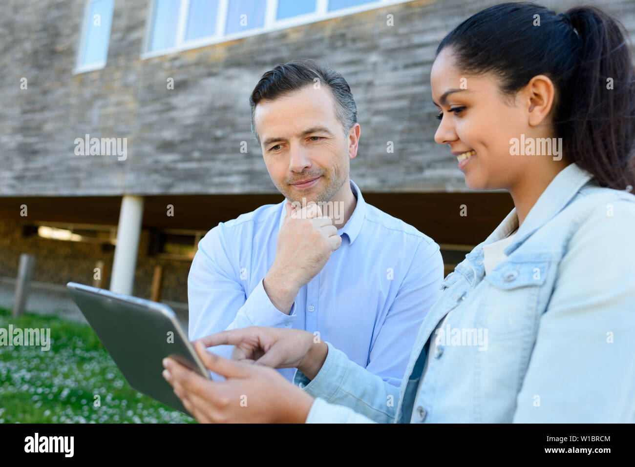 Stood standing outside building hi-res stock photography and images - Alamy