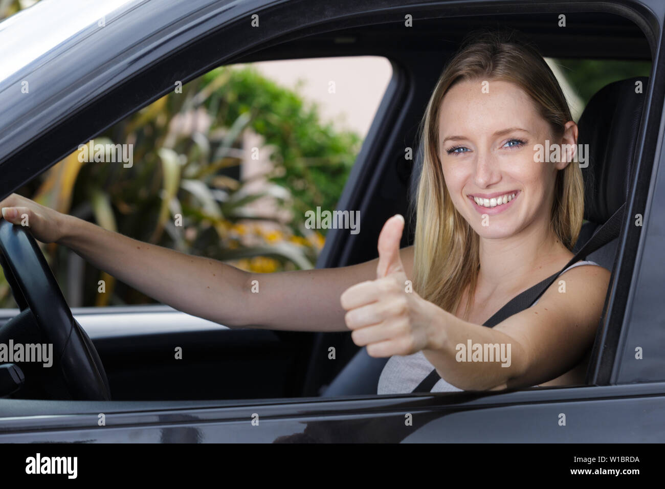 female driver showing ok sign Stock Photo - Alamy