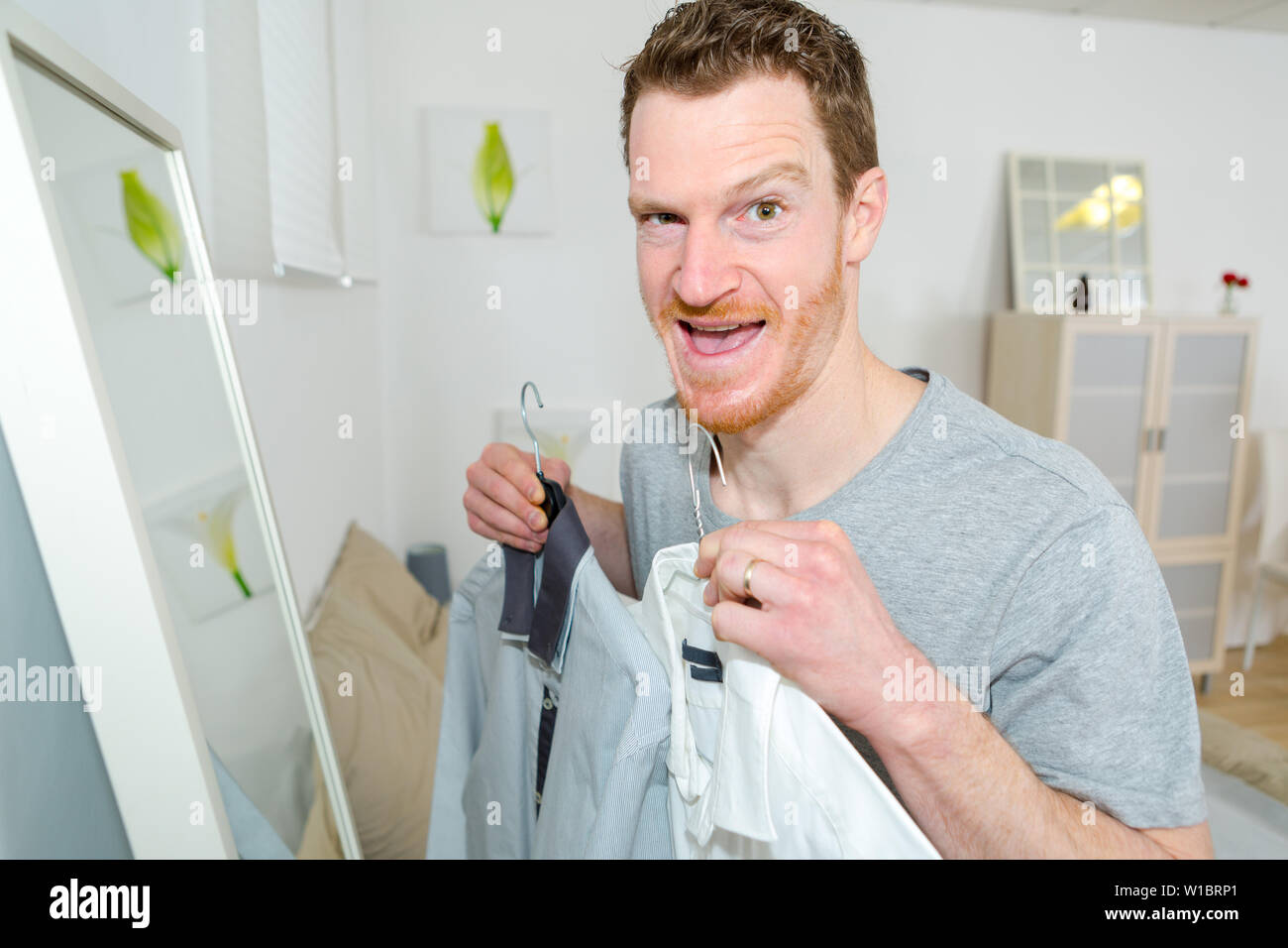 attractive guy choosing what to wear Stock Photo - Alamy