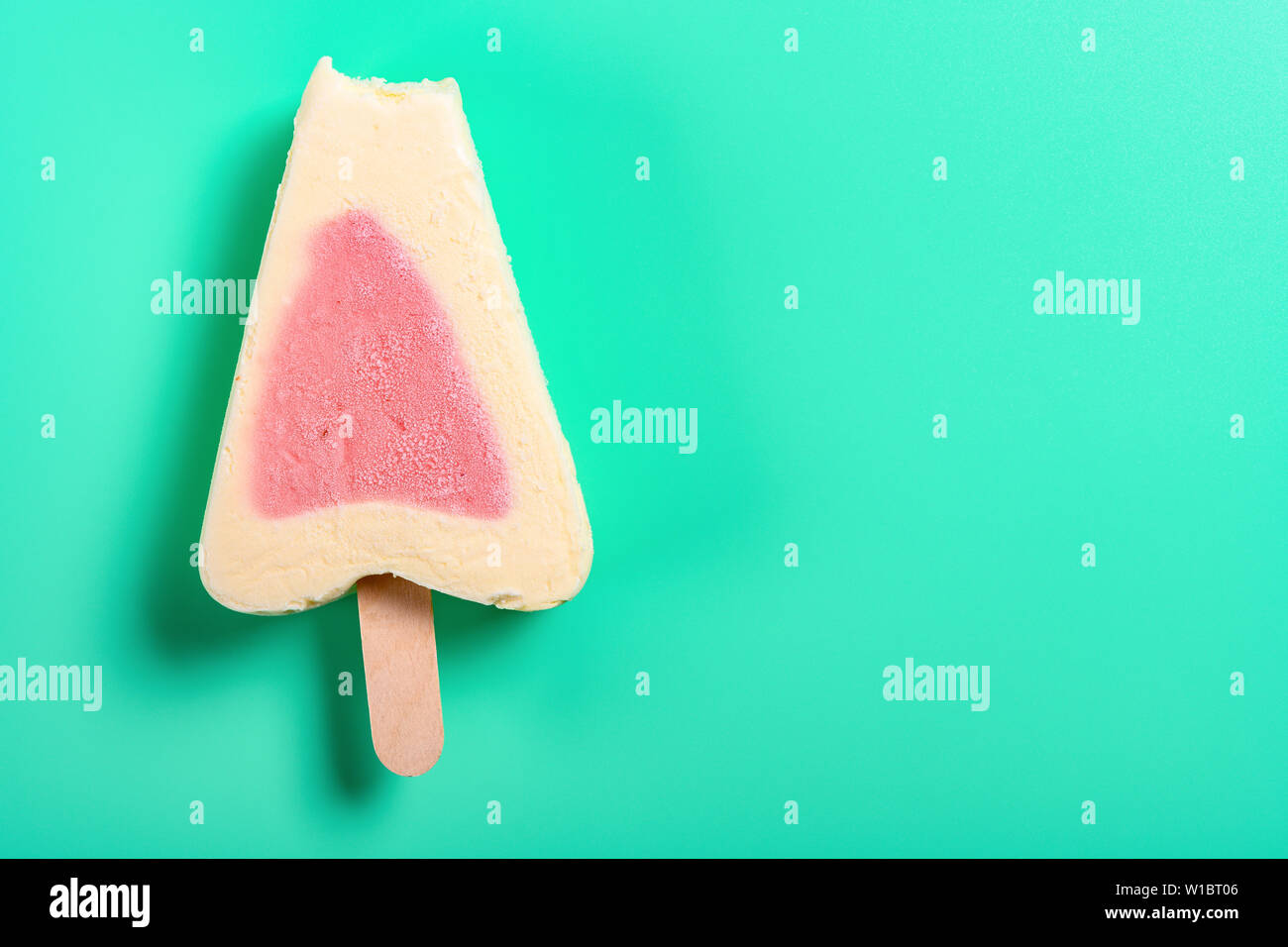 top view fresh strawberry flavor popsicle with a bite on a green ...
