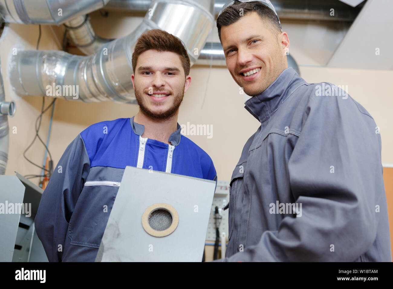 Two men wearing overalls hi-res stock photography and images - Alamy