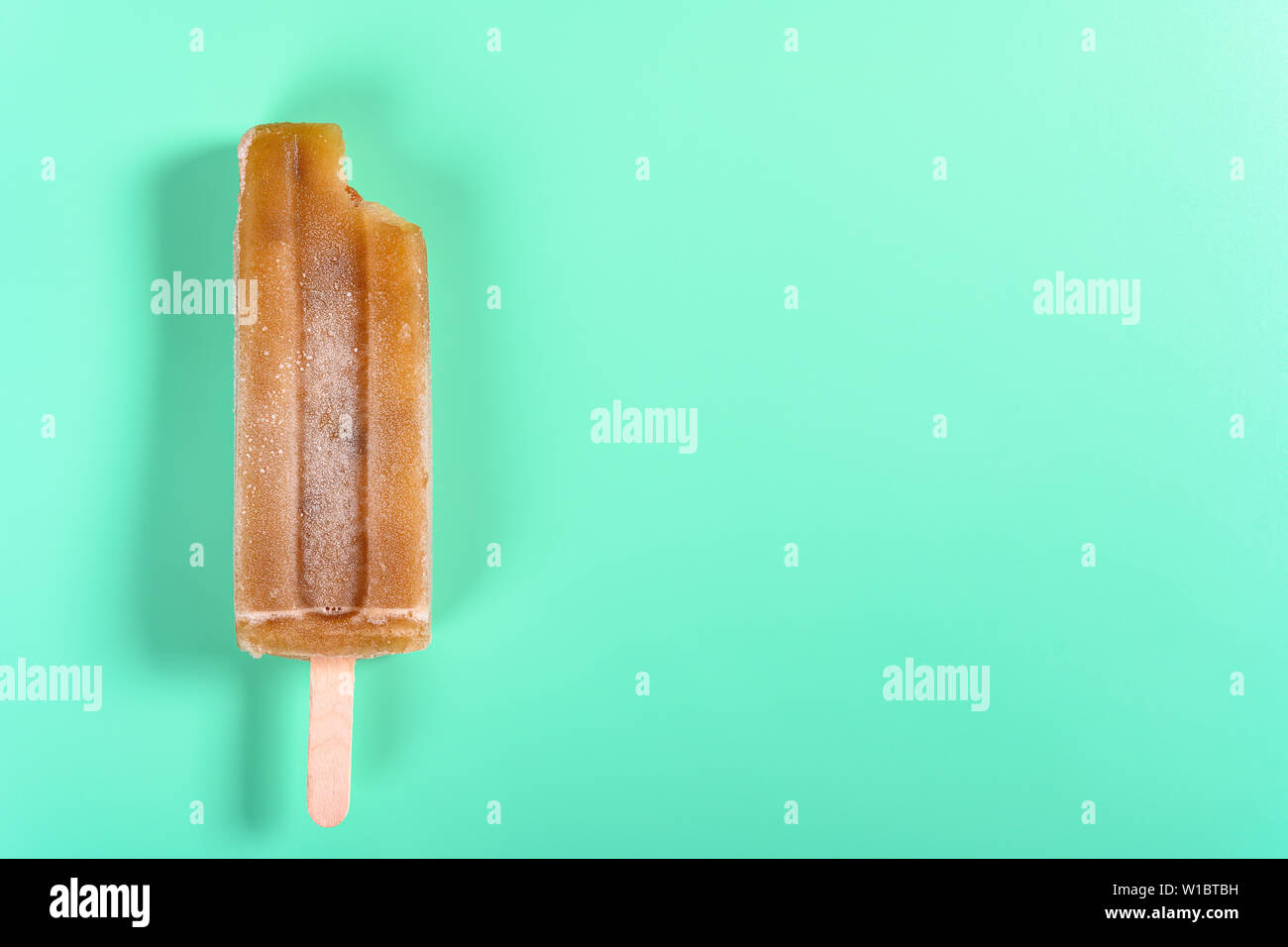 red bean popsicle with a bite on light green background Stock Photo - Alamy