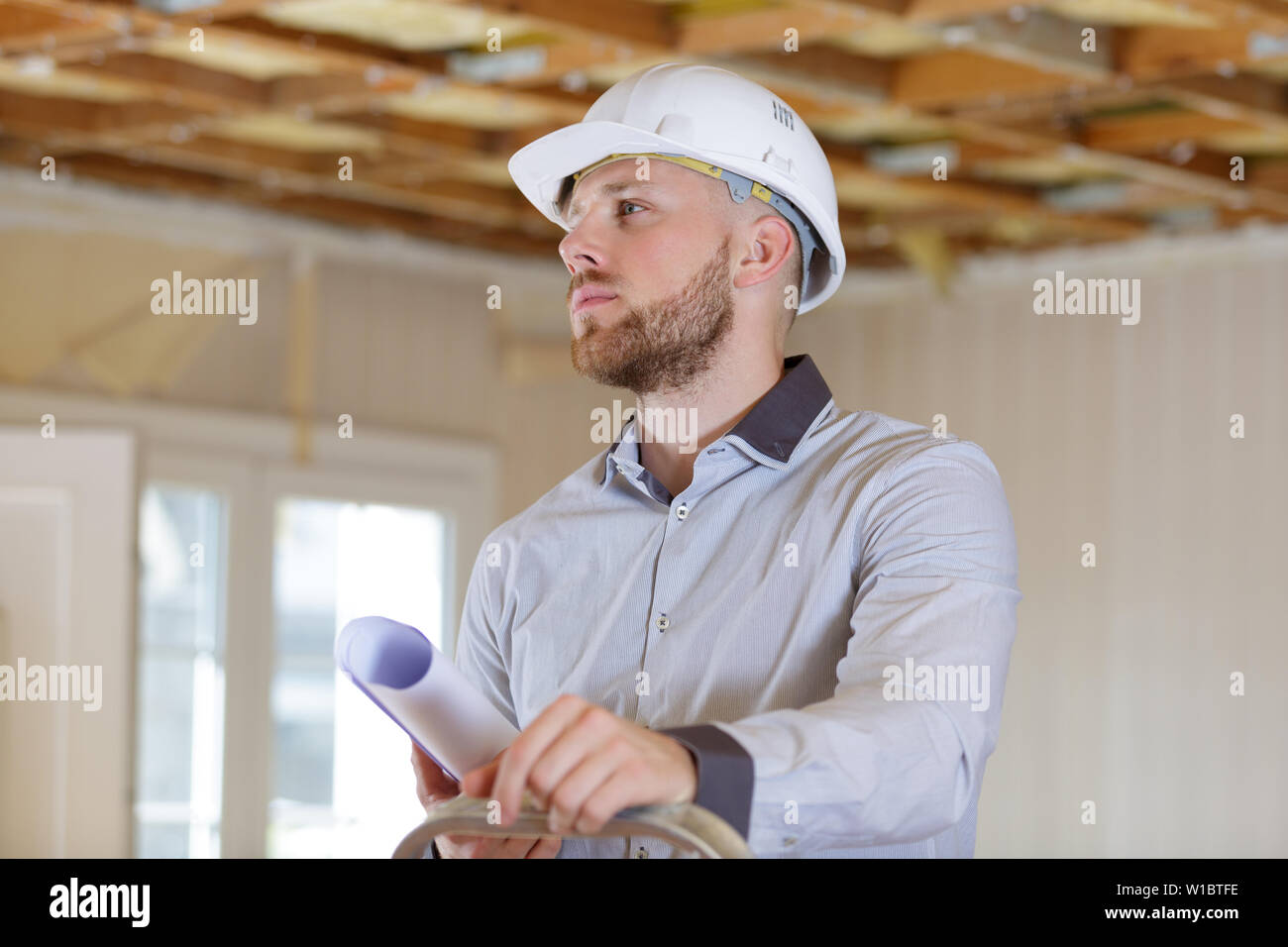 Workman climbing up ladder hi-res stock photography and images - Alamy
