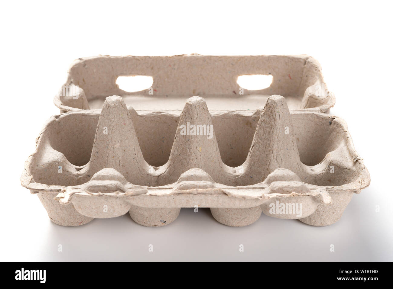 front view empty egg case on white background Stock Photo - Alamy