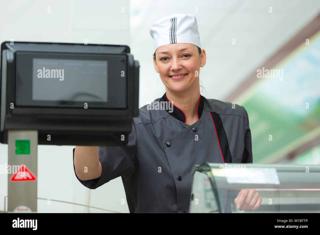 portrait of a smiling female shop keeper Stock Photo - Alamy