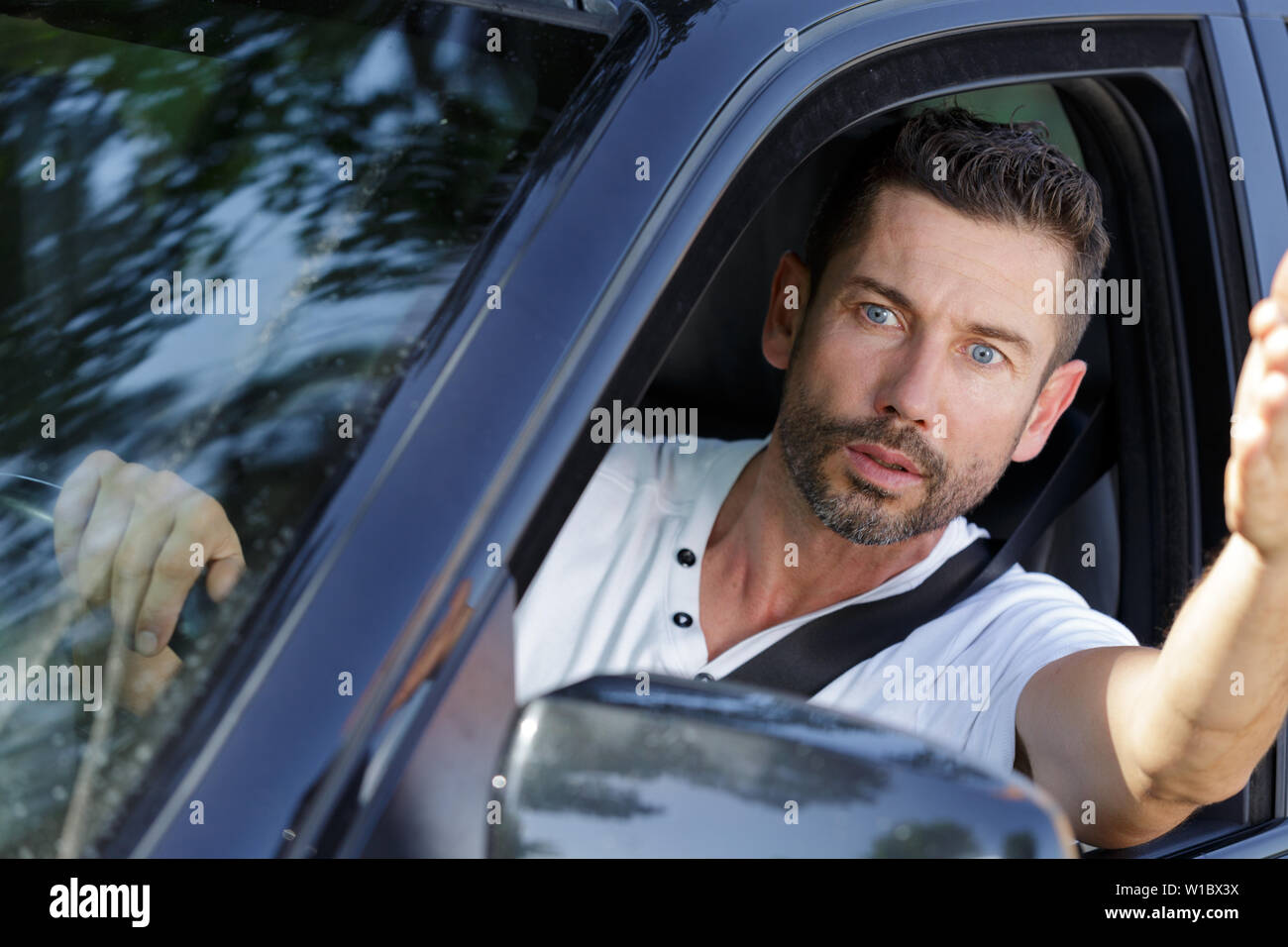 Angry man looking out window hi-res stock photography and images - Alamy