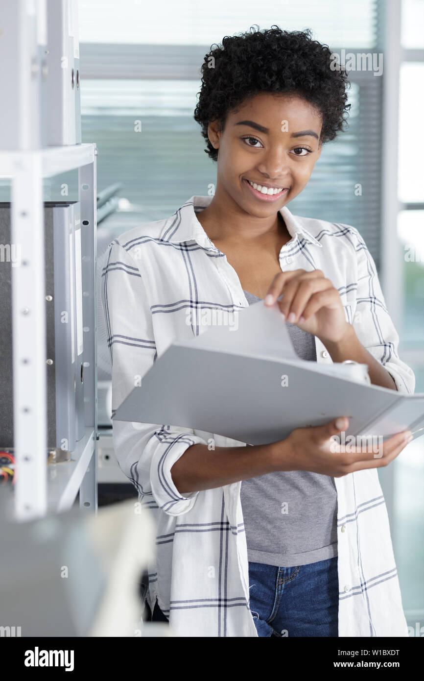 student is choosing folders on the shelves Stock Photo - Alamy