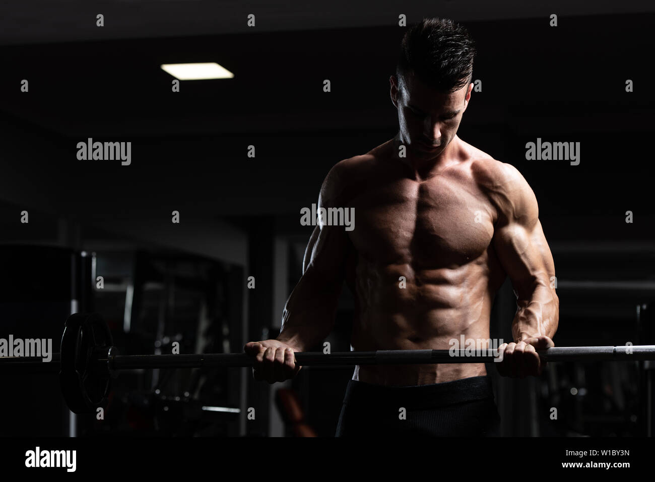 Strong man exercising gym muscular sport hi-res stock photography and ...