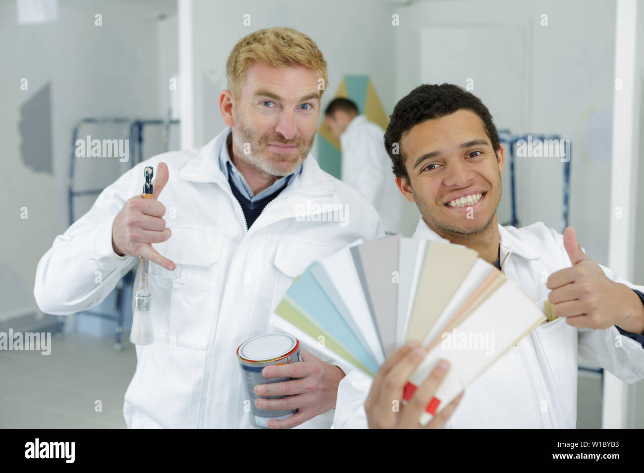 apprentice holding color wheel posing with okay sign Stock Photo - Alamy