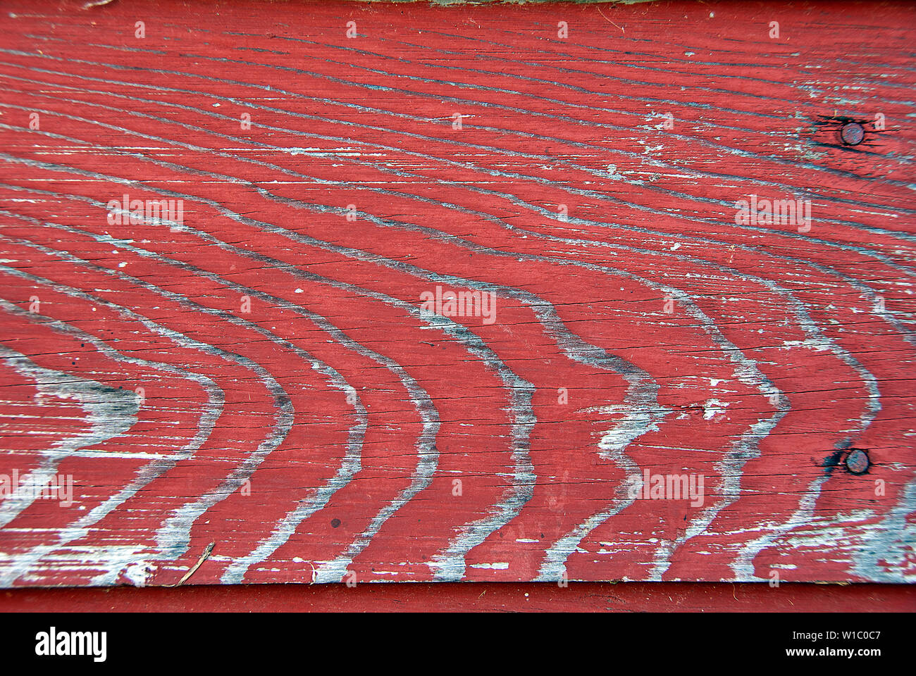 faded red paint on weathered wood with nails Stock Photo - Alamy