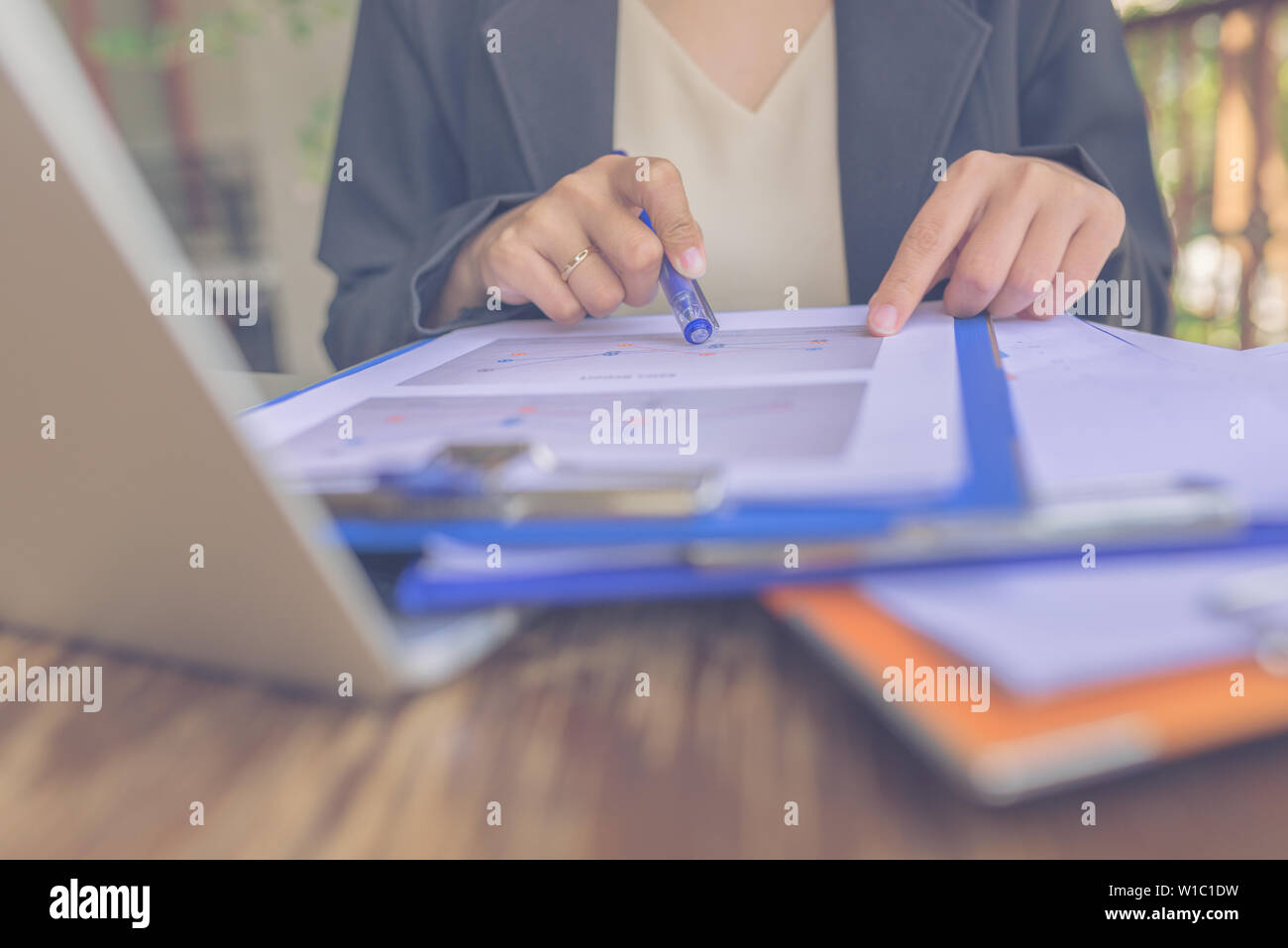 Close up photo of human hand pointing on document Stock Photo - Alamy