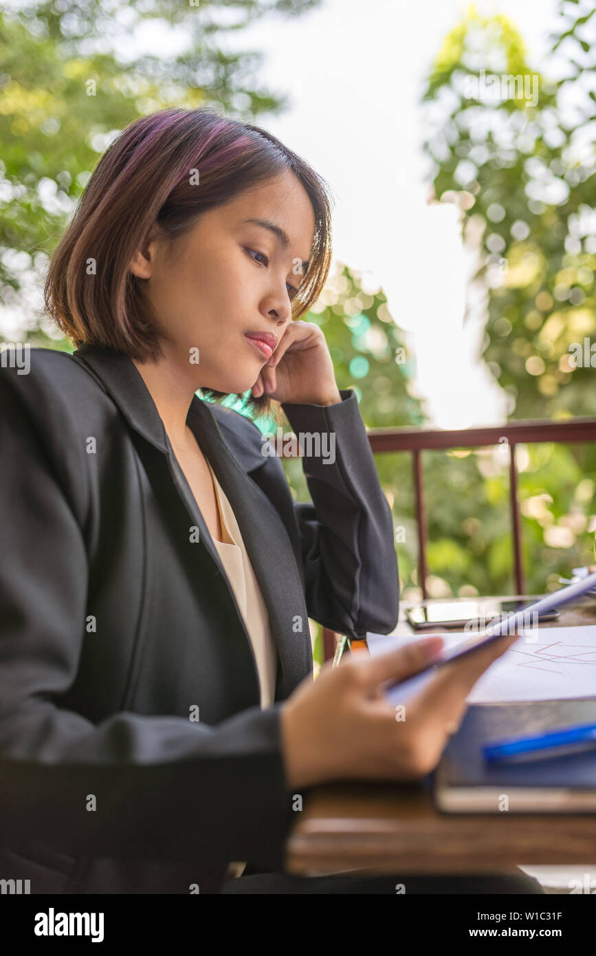 Portrait of young hard-working woman in black suit Stock Photo - Alamy