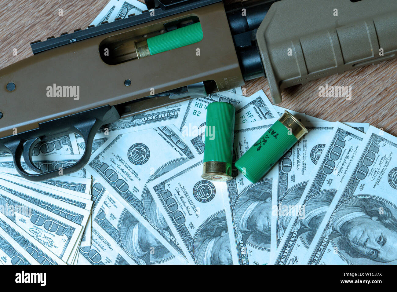 Shotgun and cartridges on dollars. Concept for crime, global arms trade ...