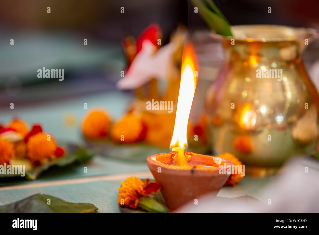 Diya lighting during a Hindu wedding ceremony Stock Photo - Alamy