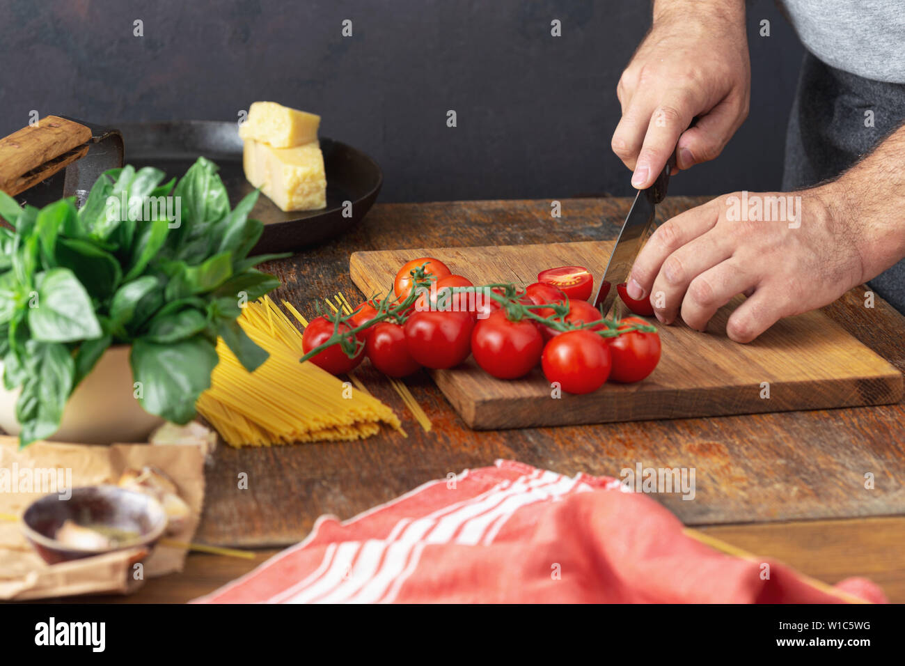 Chef cooking pasta with tomatoes in the kitchen Stock Photo - Alamy