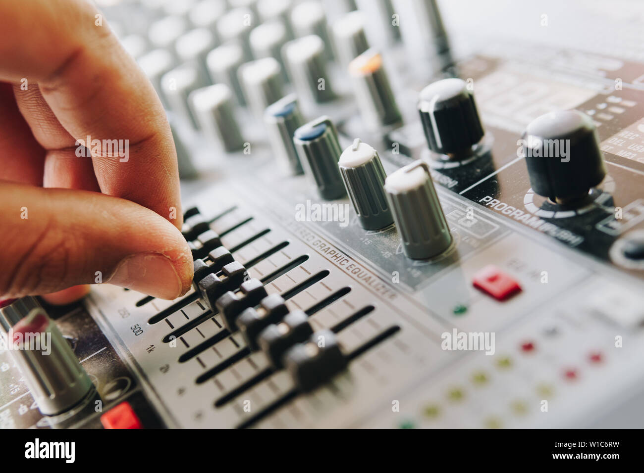 Hand adjusting audio mixer sound Stock Photo - Alamy