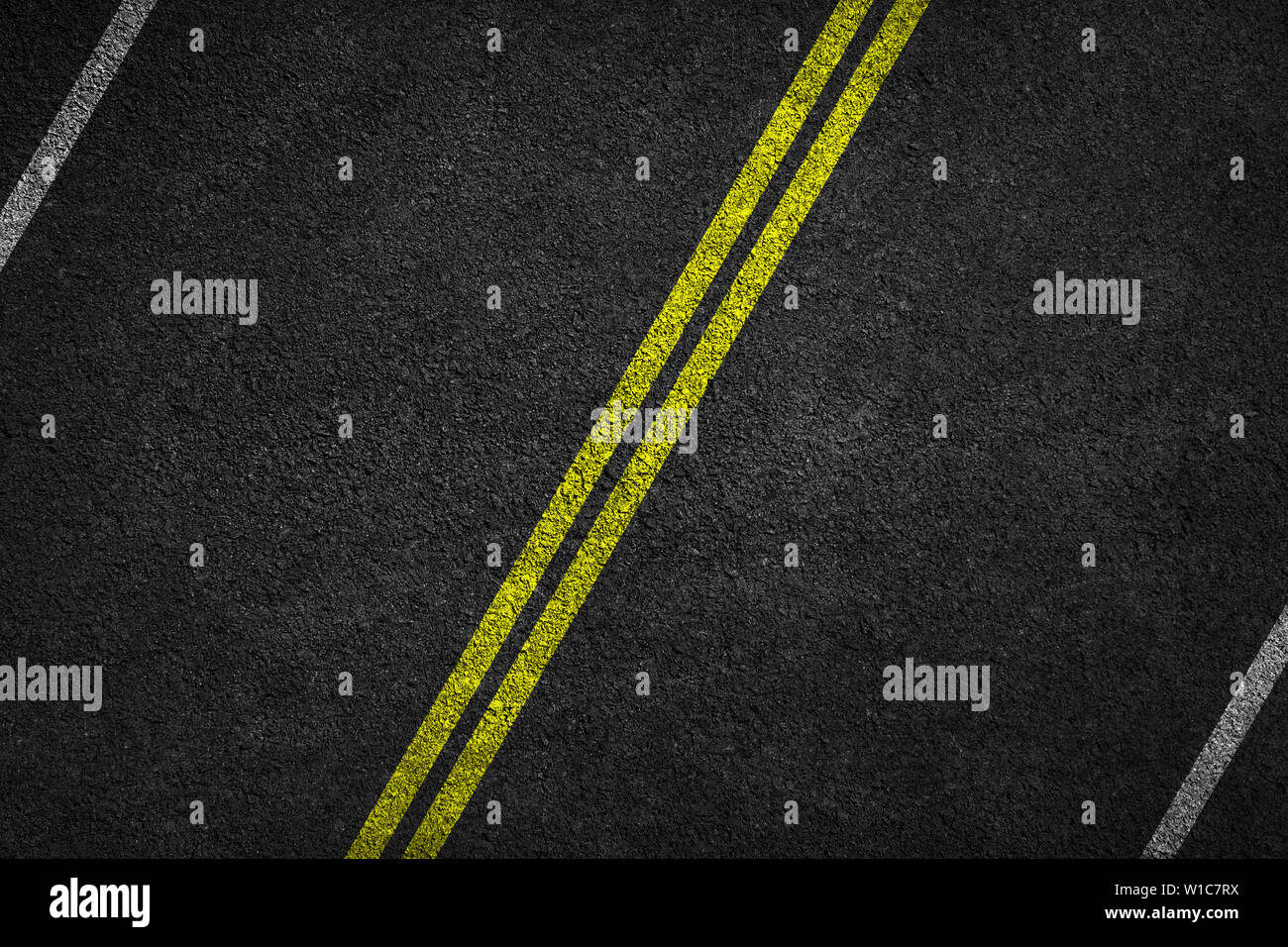 Structure of granular asphalt. Asphalt texture with two yellow line ...