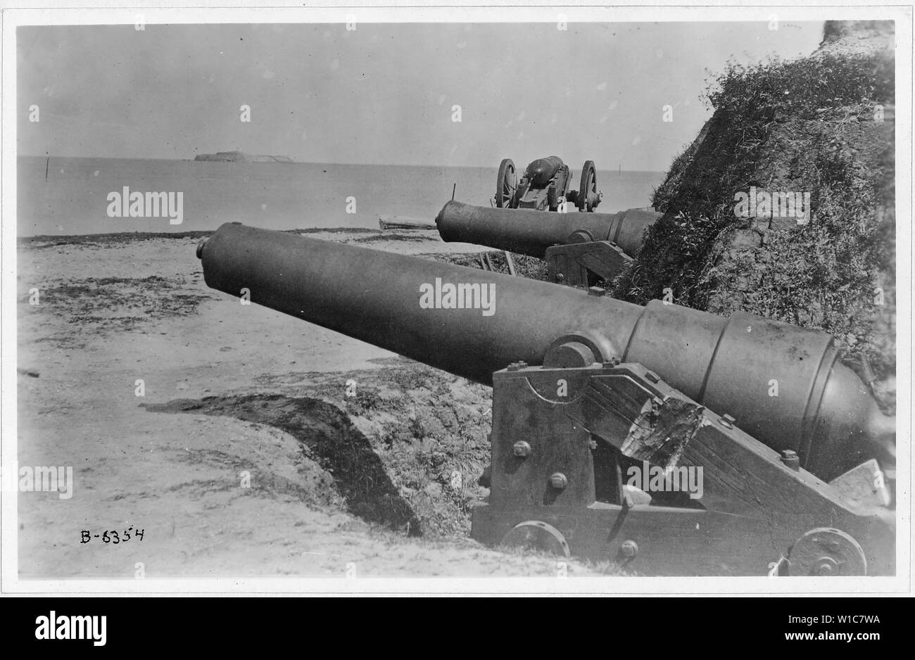 Distant view of Ft. Sumter from Fort Johnson, S.C.; The foreground weapon is a Confederate-made ...