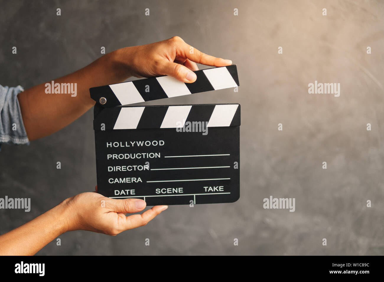 Hand holding film clap board hi-res stock photography and images - Alamy