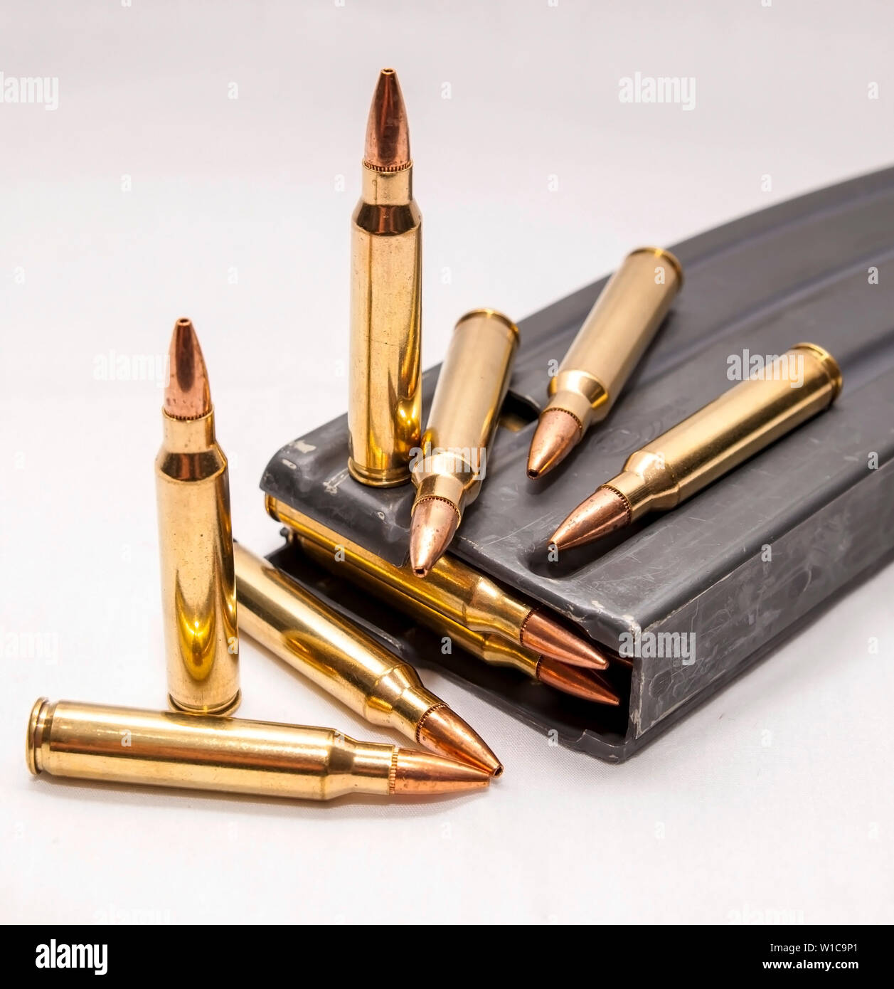 223 caliber bullets along with a loaded 223 caliber rifle magazine on a ...