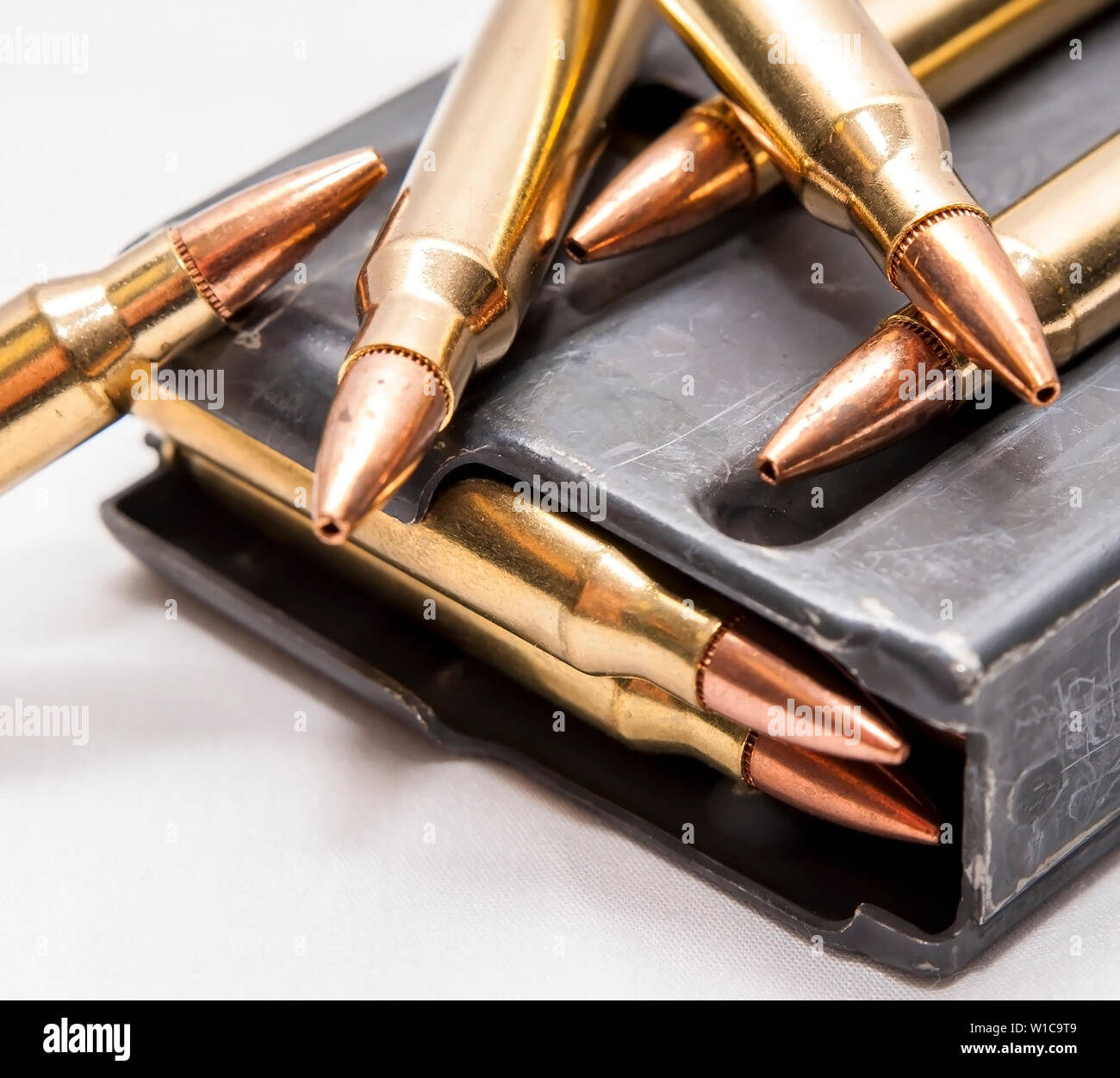 223 caliber bullets along with a loaded 223 caliber rifle magazine on a ...