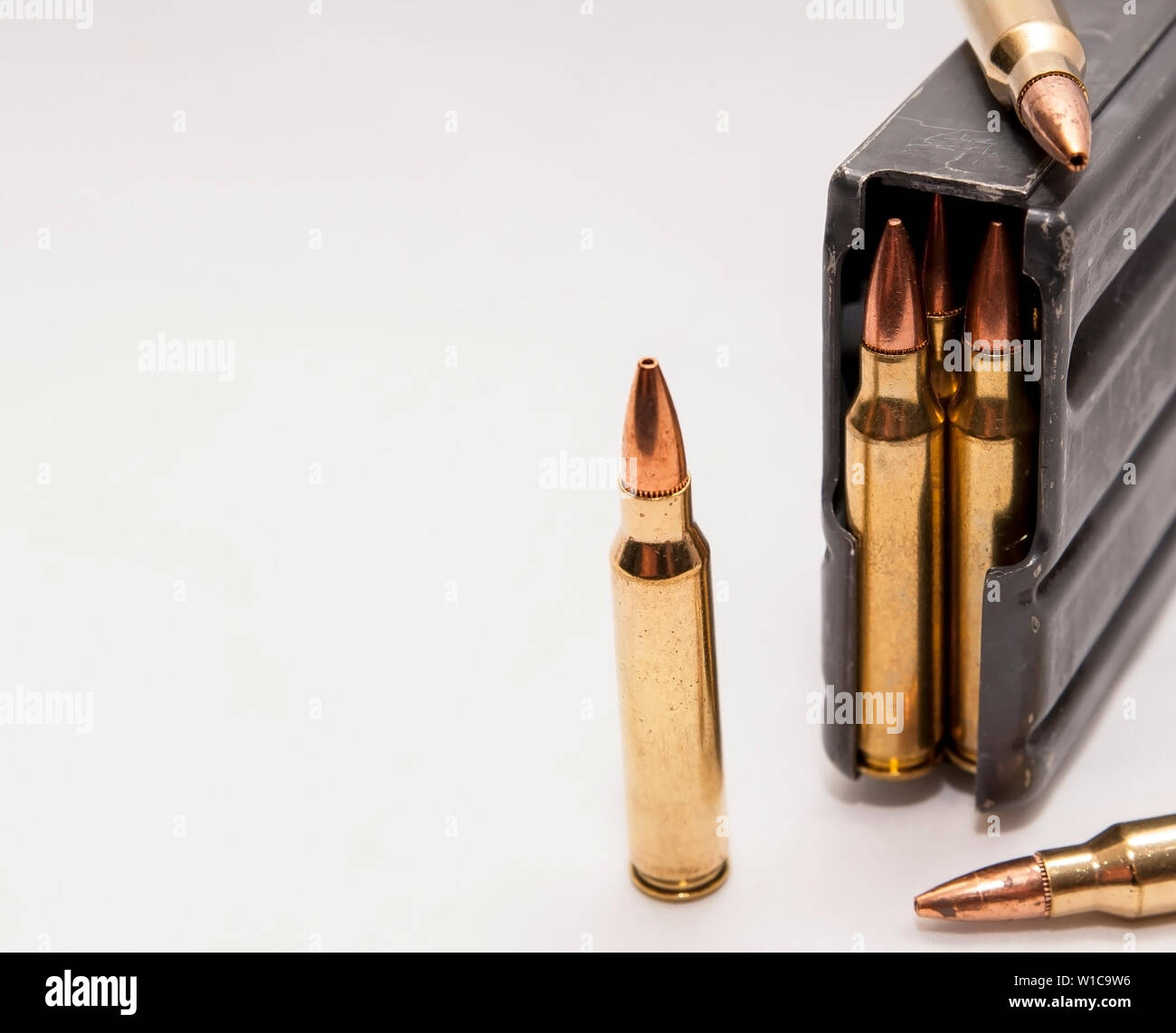 223 caliber bullets along with a loaded 223 caliber rifle magazine on a ...