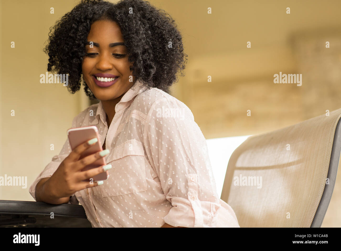 Happy African American woman texting and talking Stock Photo - Alamy Happy African American woman texting and talking Stock Photo - Alamy