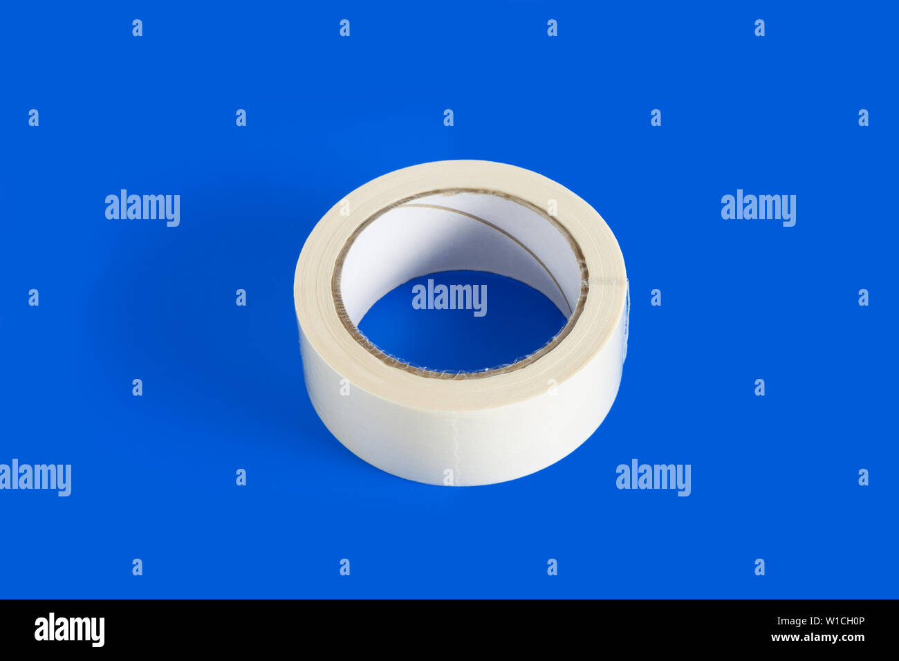 Masking tape paper. Close-up on a blue background Stock Photo - Alamy