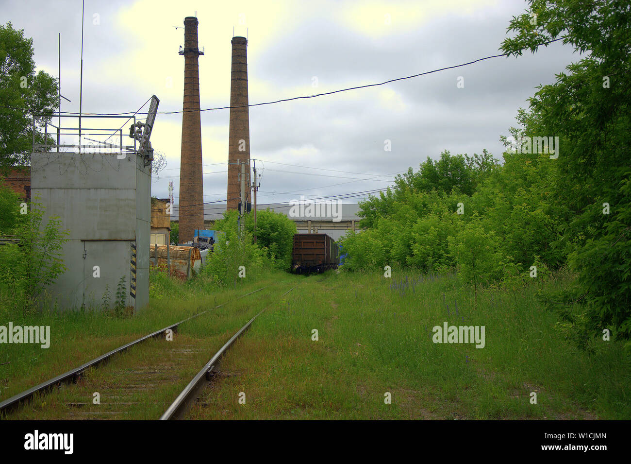 The end of an abandoned railway line of old cars and pipes of an ...