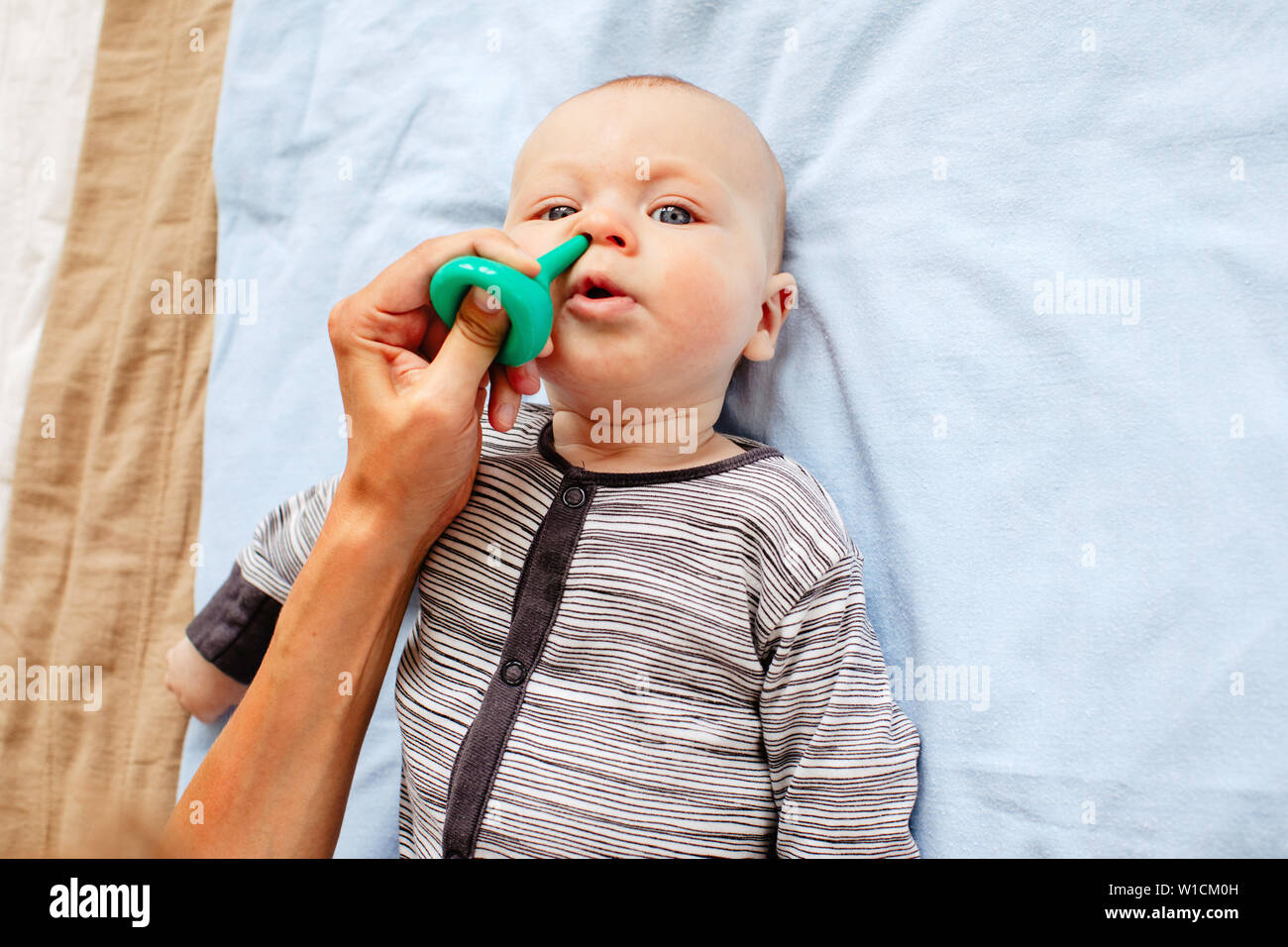 Mother cleaning nose of cute baby Stock Photo - Alamy