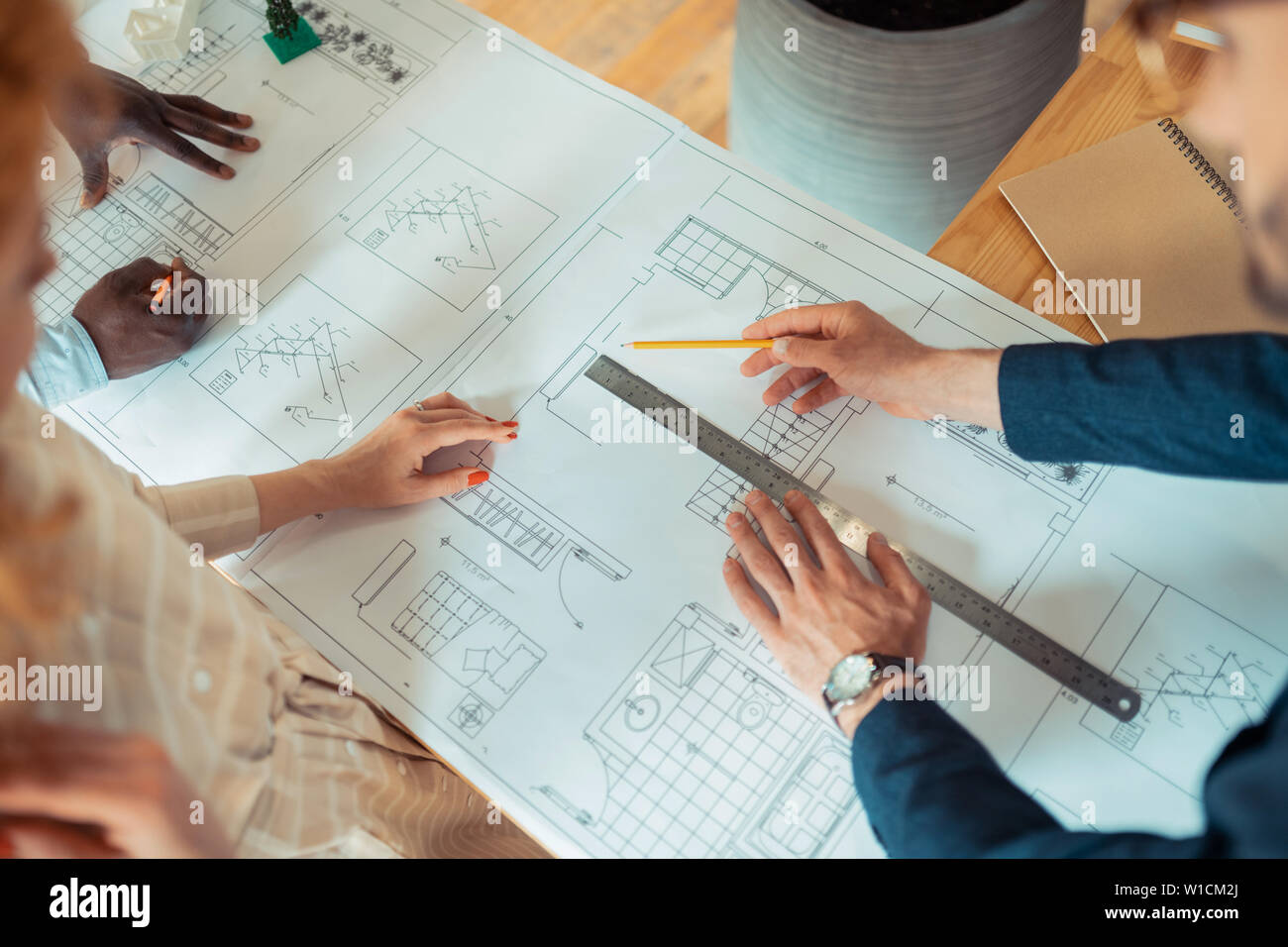 Ruler and pencil. Men and woman using ruler and pencil while drawing ...