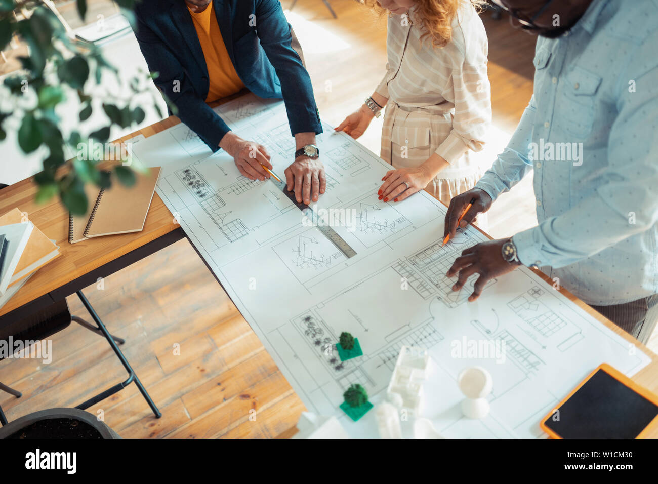 Designers cooperating. Top view of men and woman cooperating while ...