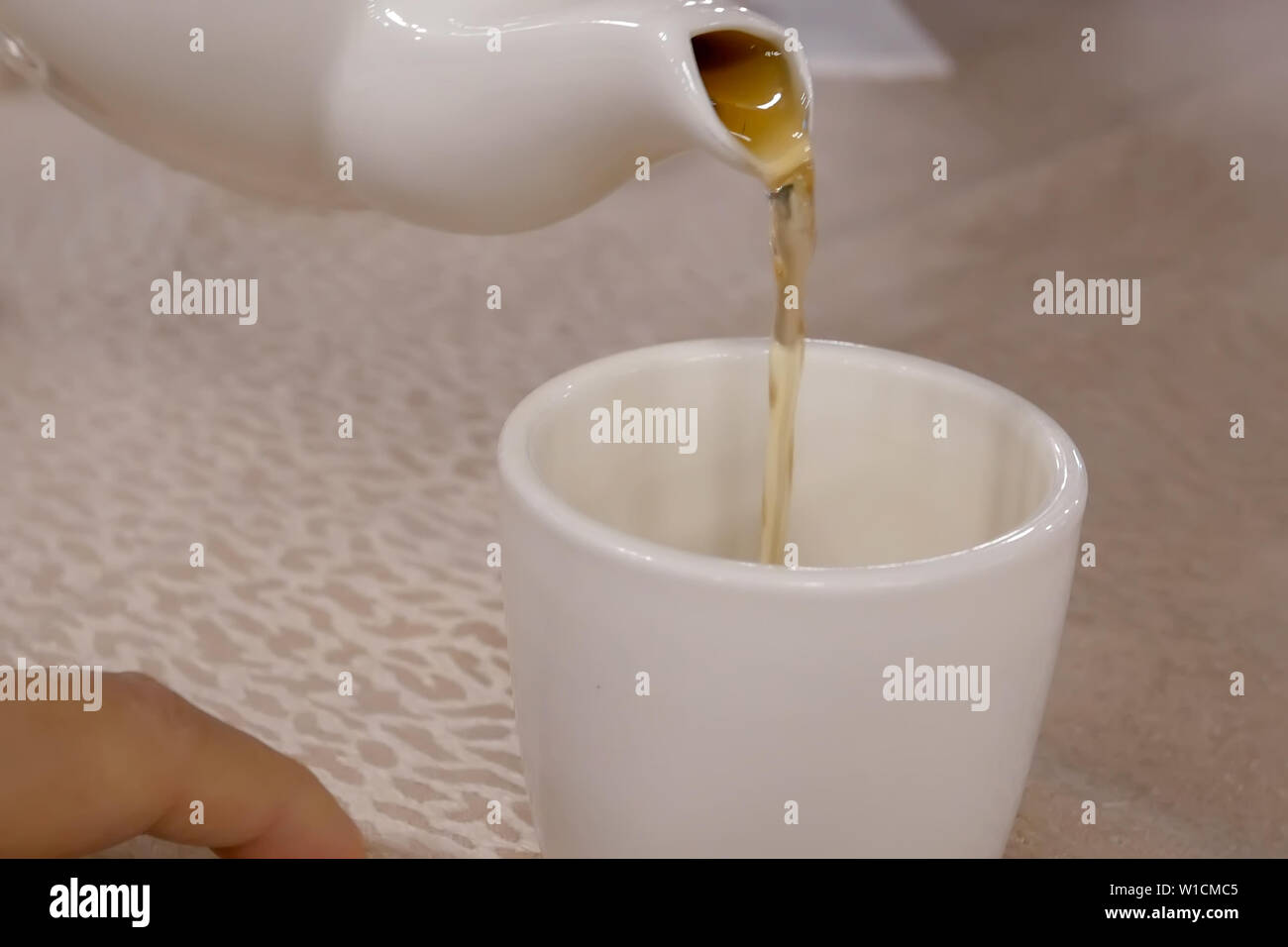 Motion of people pouring hot tea inside Chinese restaurant Stock Photo ...