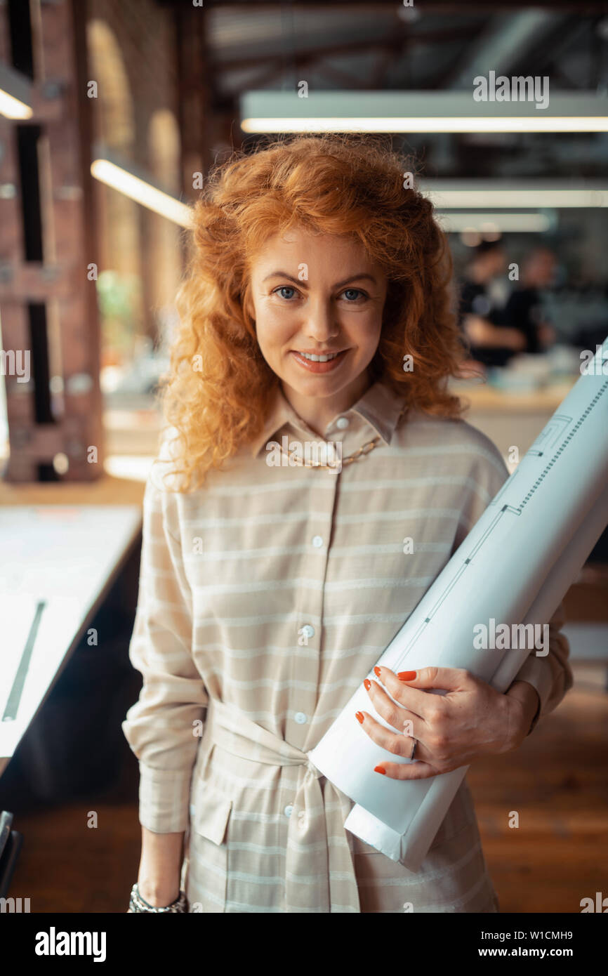 Before starting work. Beautiful woman working in publishing office ...