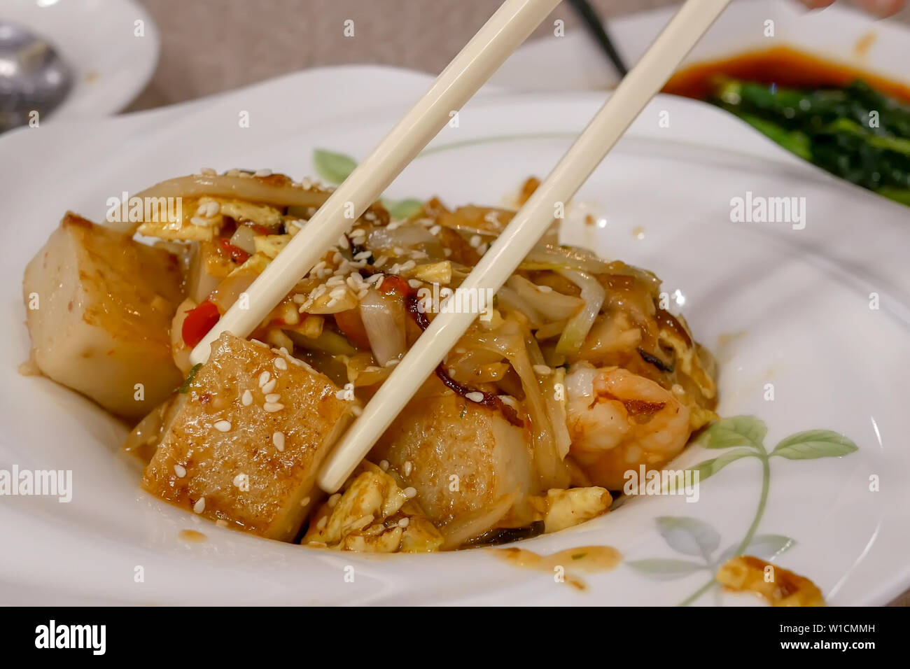 Motion of people eating pan fried turnip cake dim sum inside Chinese ...