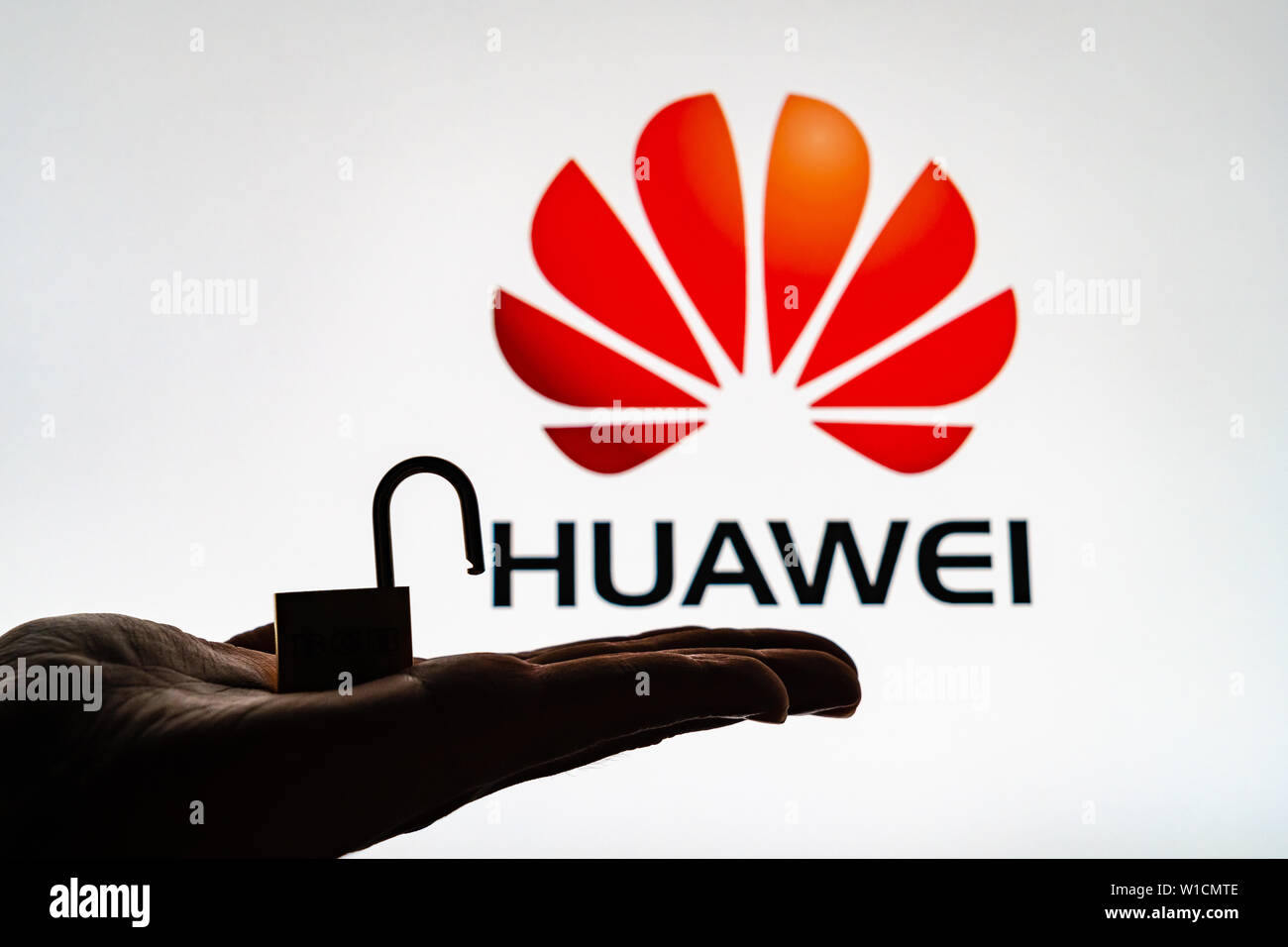 Huawei logo in background with silhouette of a unlock padlock and a key ...