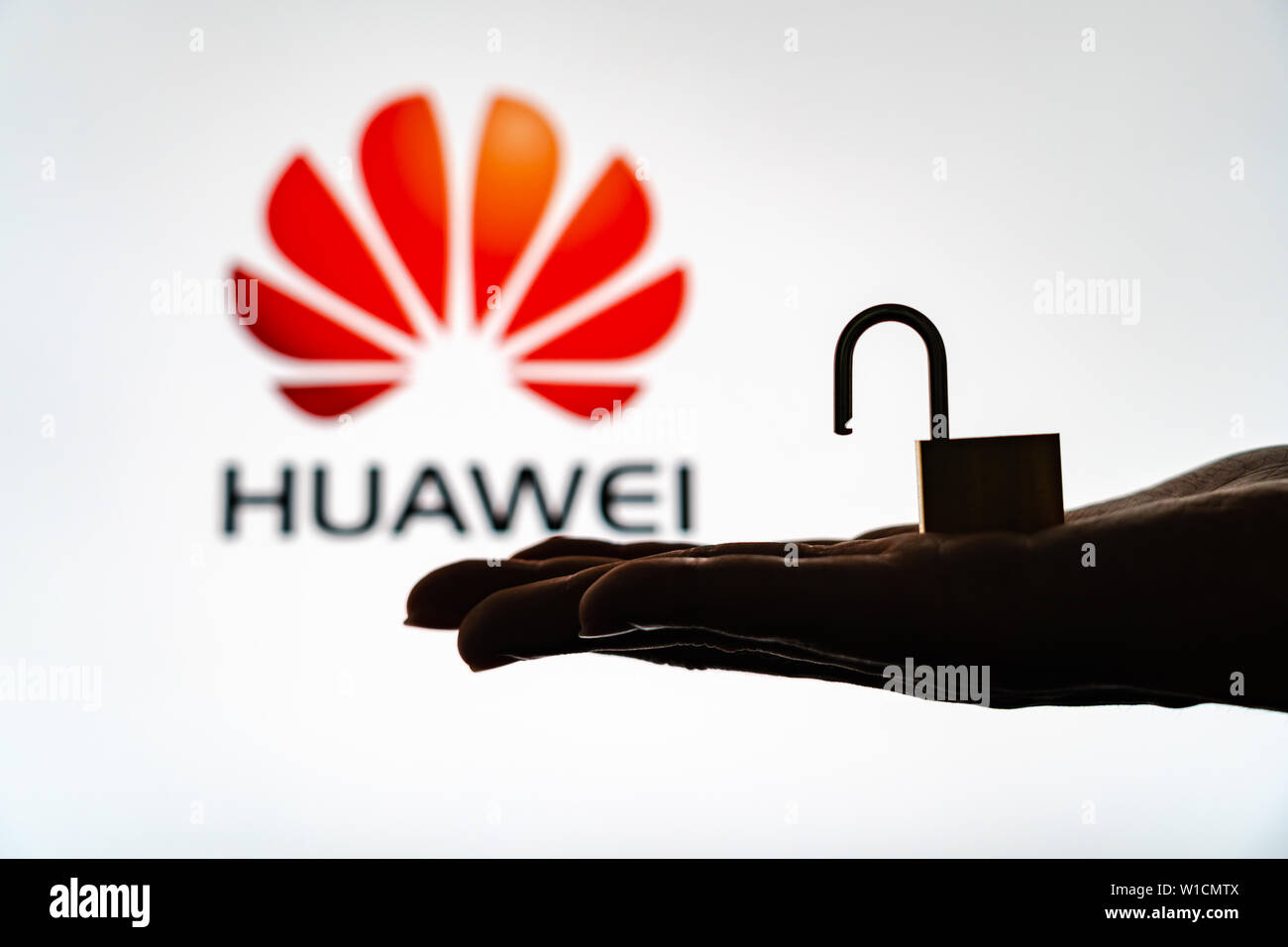 Huawei logo in background with silhouette of a unlock padlock and a key ...