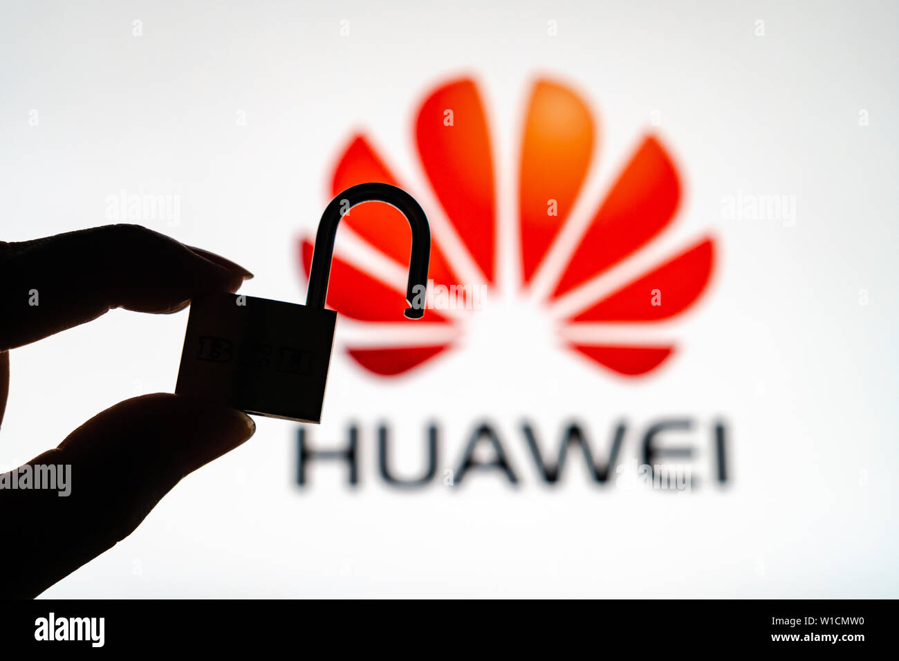 Huawei logo in background with silhouette of a unlock padlock and a key ...