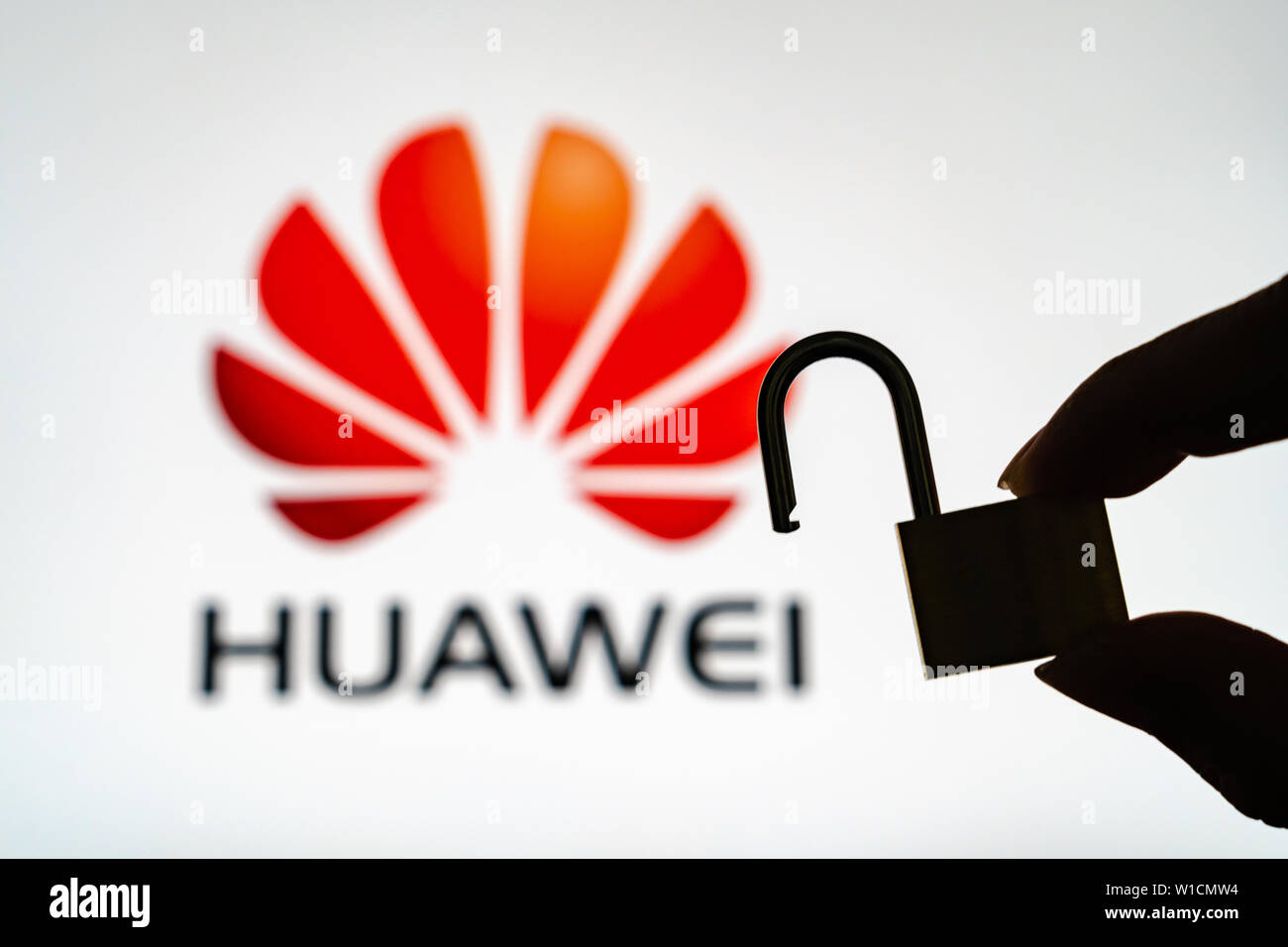 Huawei logo in background with silhouette of a unlock padlock and a key ...