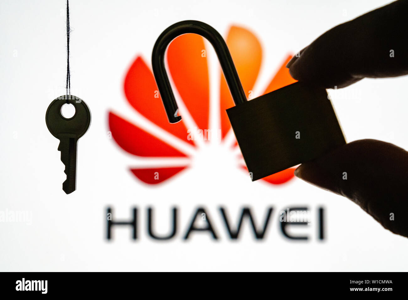 Huawei logo in background with silhouette of a unlock padlock and a key ...
