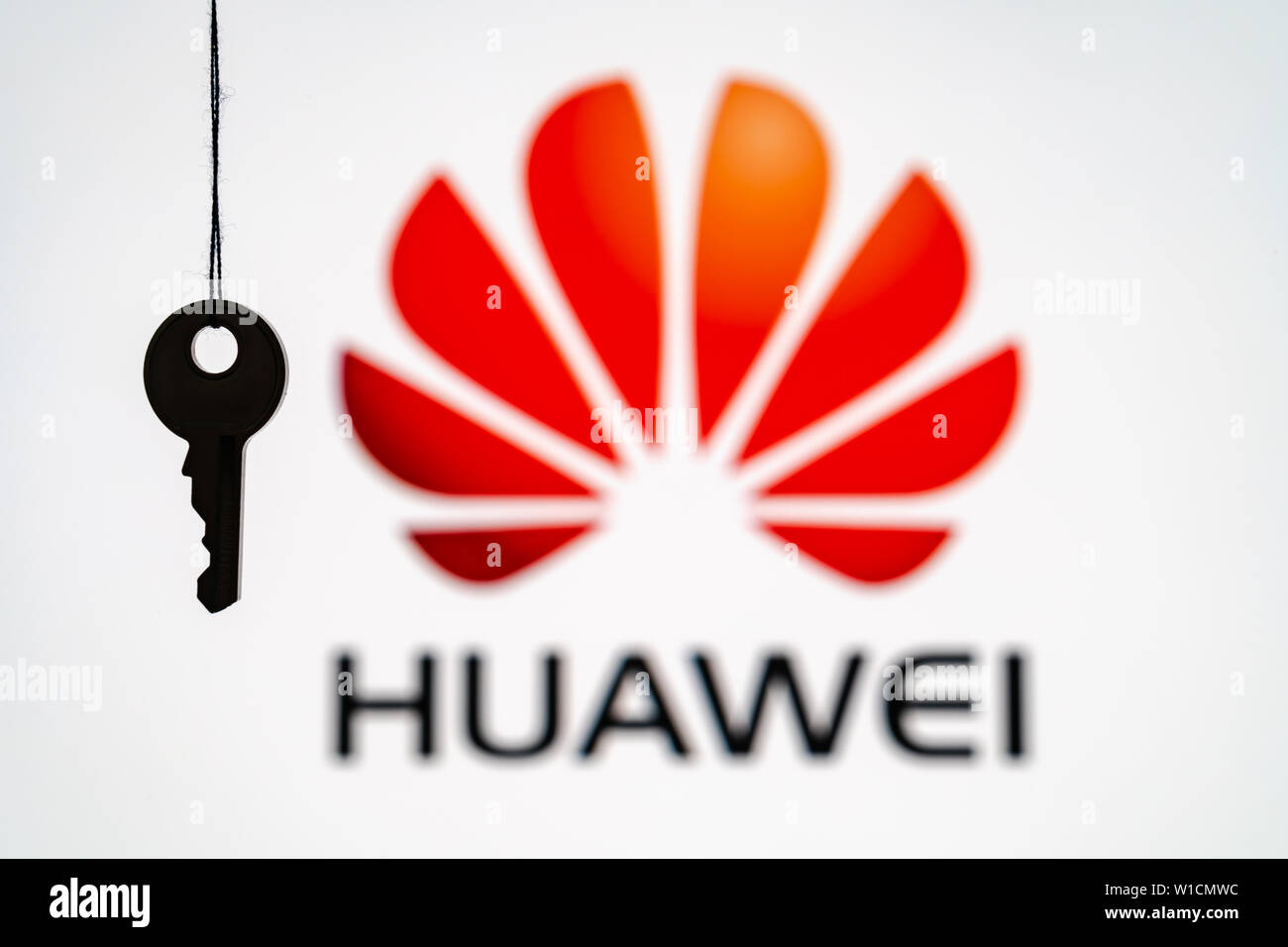 Huawei logo in background with silhouette of a unlock padlock and a key ...