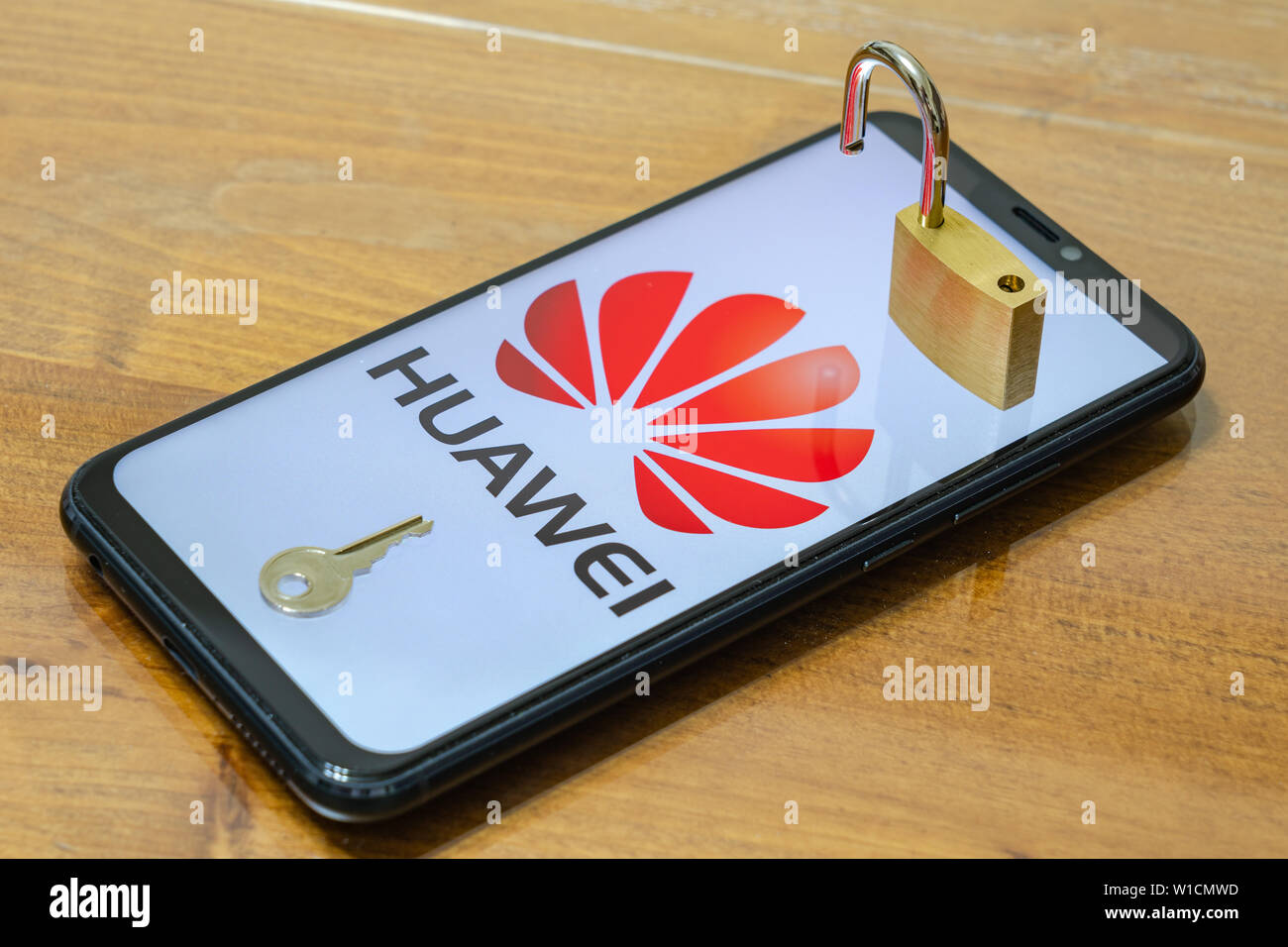 Huawei logo in background with silhouette of a unlock padlock and a key ...