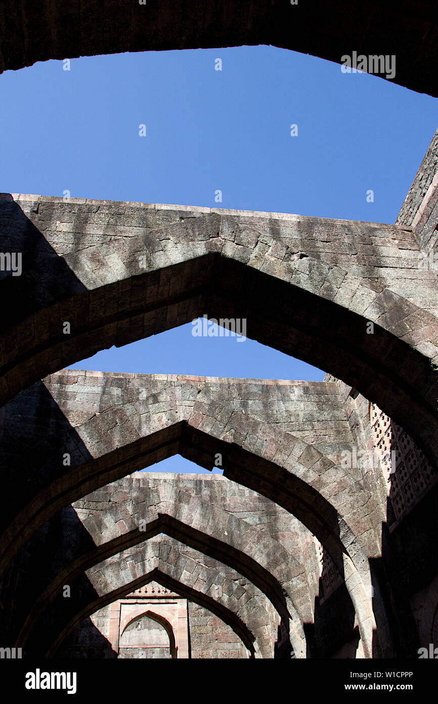Low angle view of stone arches of Hindola Mahal or Swinging Palace ...